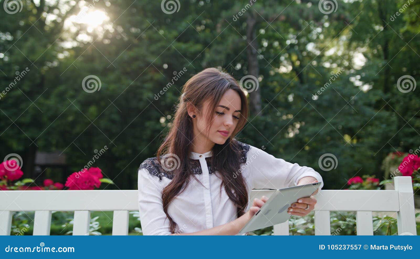 Lady in the Park Using a Tablet Stock Image - Image of flowers, plastic ...