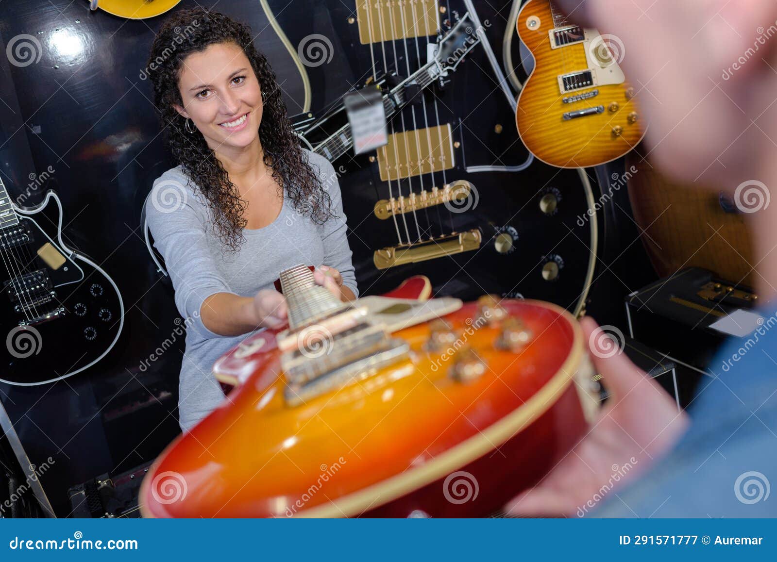Lady Passing Guitar Forward Stock Image - Image of shop, rock: 291571777