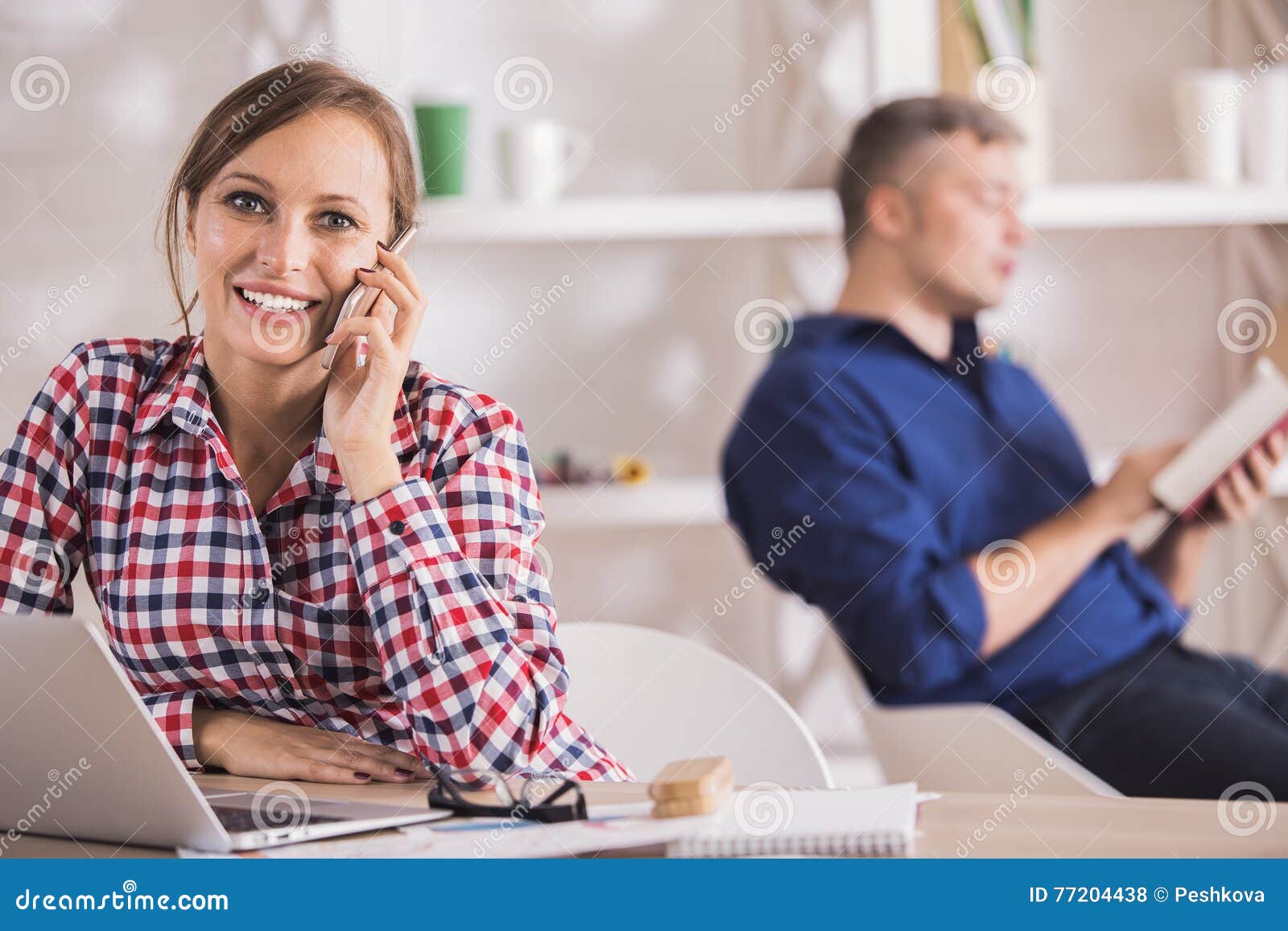 Lady on phone using laptop stock photo. Image of lifestyle - 77204438