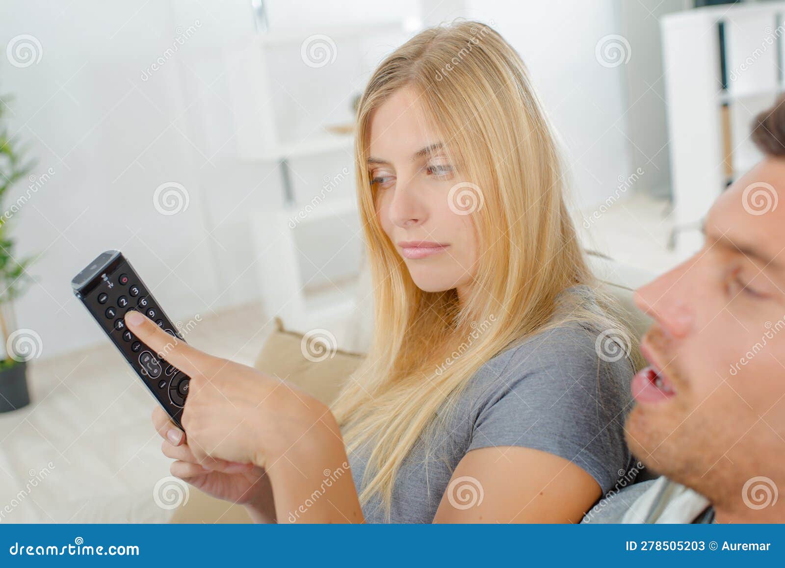 Lady Pointing To Remote Control with Partner Stock Image - Image of ...