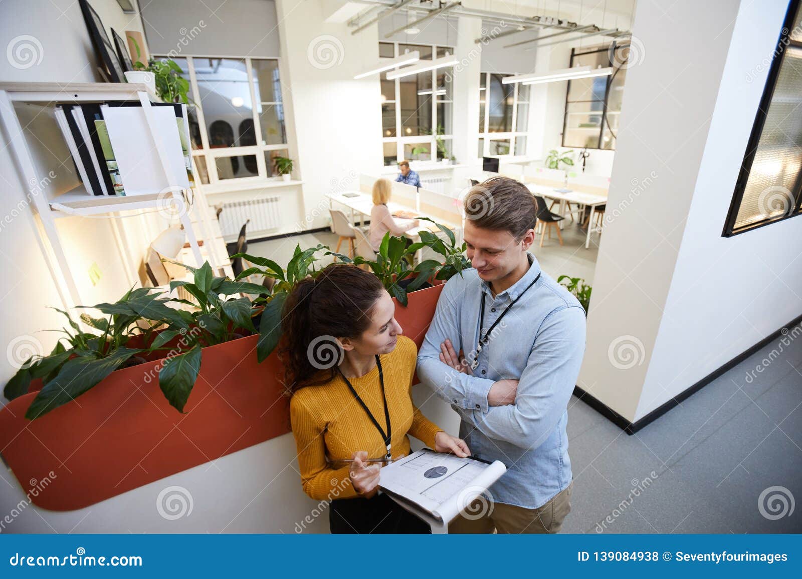 Lady Presenting Graphs To Colleague Stock Photo - Image of standing ...