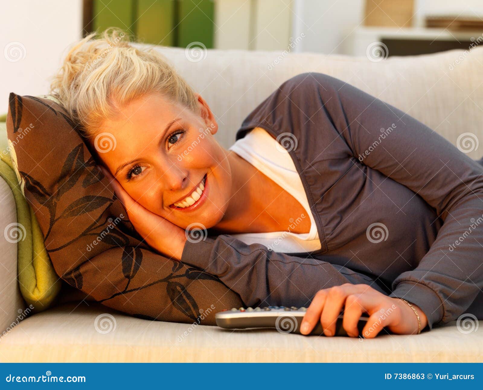 Lady Resting on a Couch and Holding Remote Stock Image - Image of lady ...