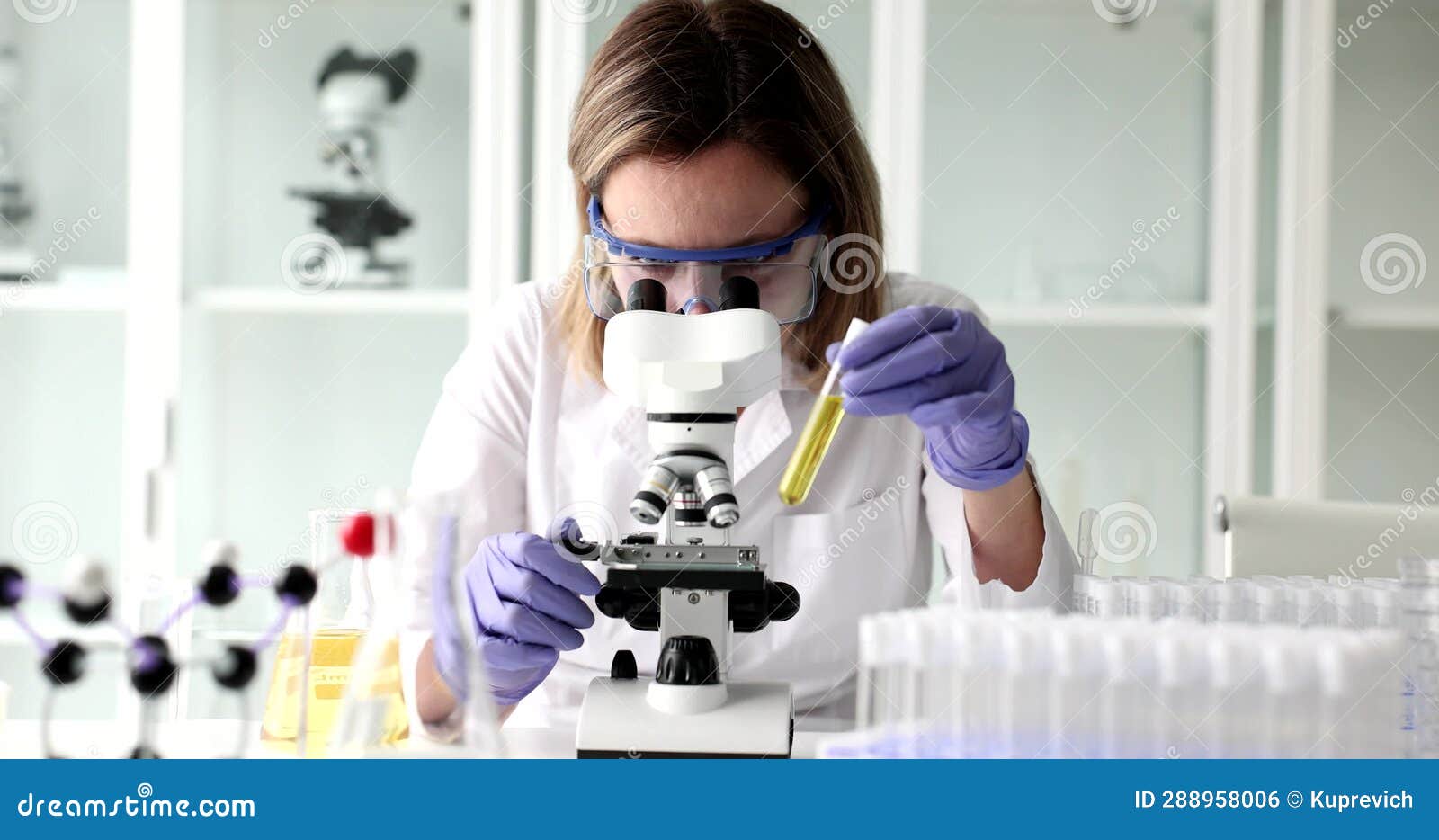 Lady Scientist Examines Sample Under Microscope Holding Flask Stock ...