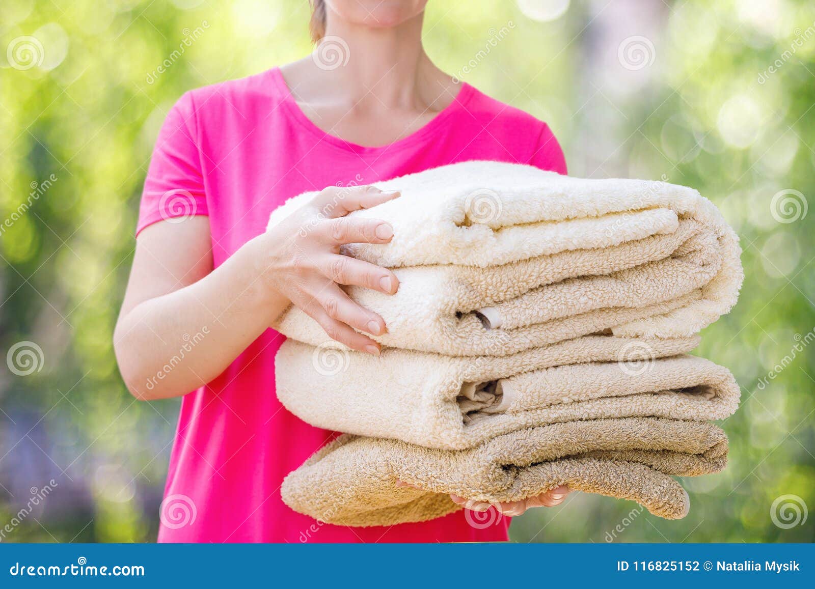 The Lady Shows the Clean Sheets on the Blurred Background. Stock Photo ...