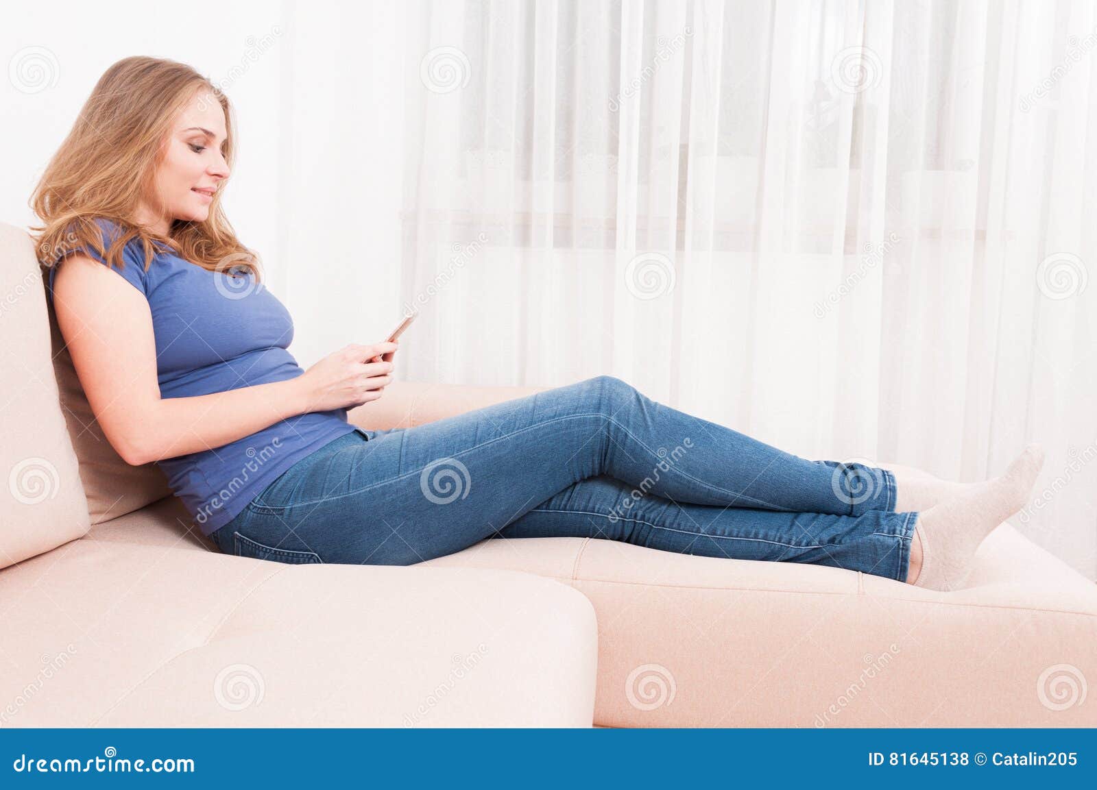 Lady Sitting on Couch Texting on Smartphone Stock Photo - Image of area ...