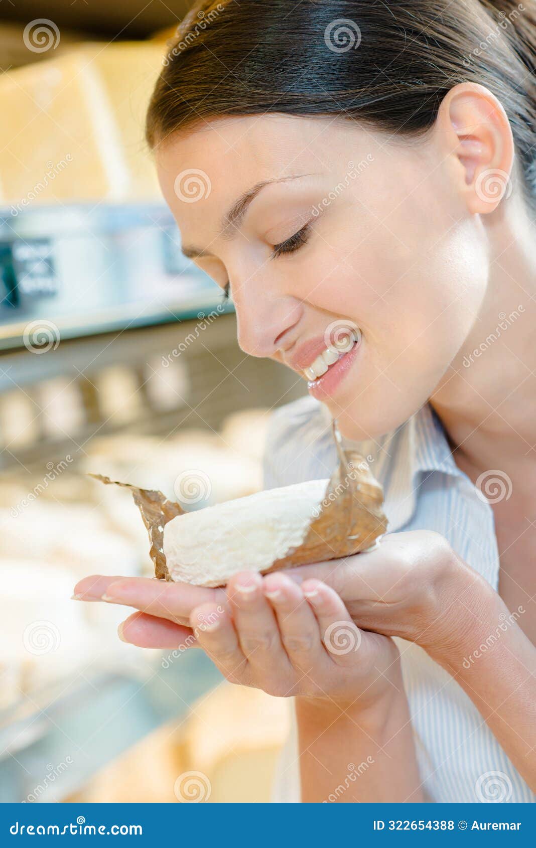 Lady smelling cheese stock photo. Image of customer - 322654388