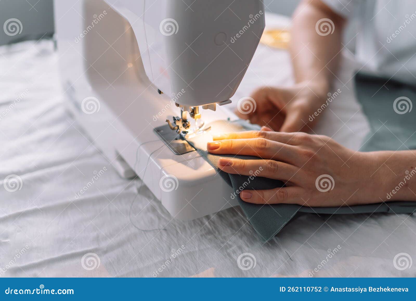 Lady Stitching the Edges of the Fabric of a Sewing Machine Stock Photo ...