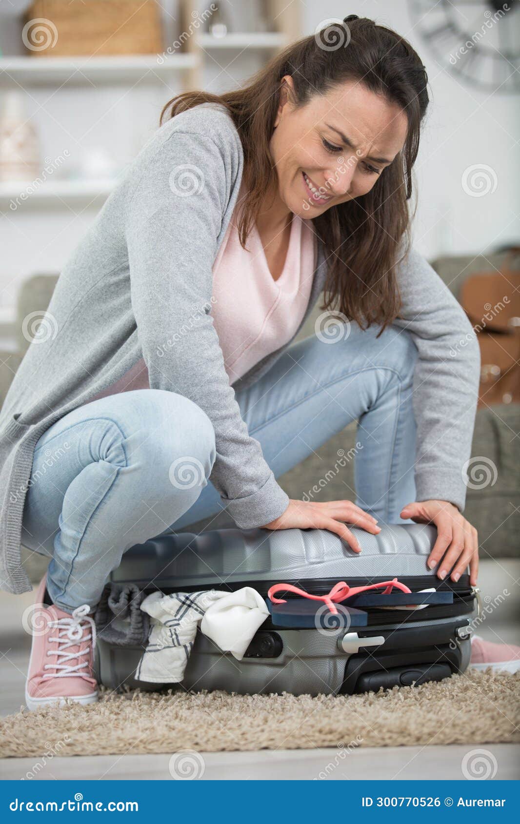 Lady Trying To Close Bulging Suicase Stock Photo - Image of cram, confusion: 300770526