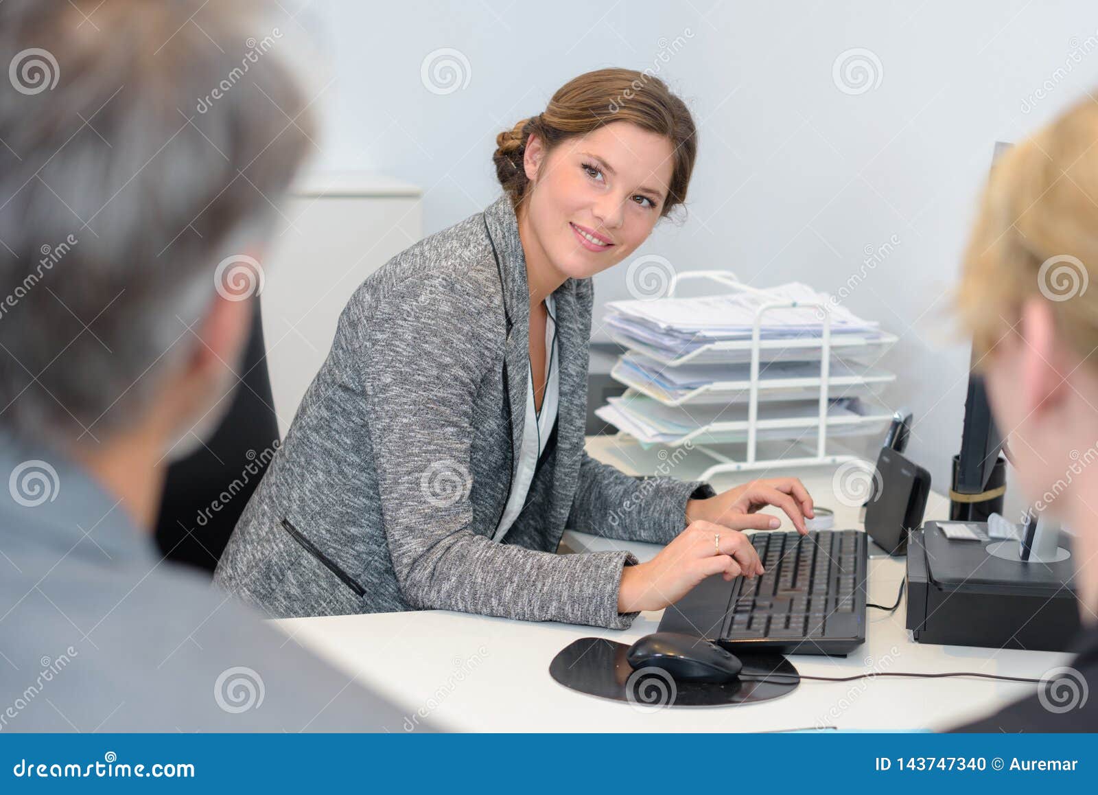 Lady Typing while in Meeting with Couple Stock Photo - Image of ...