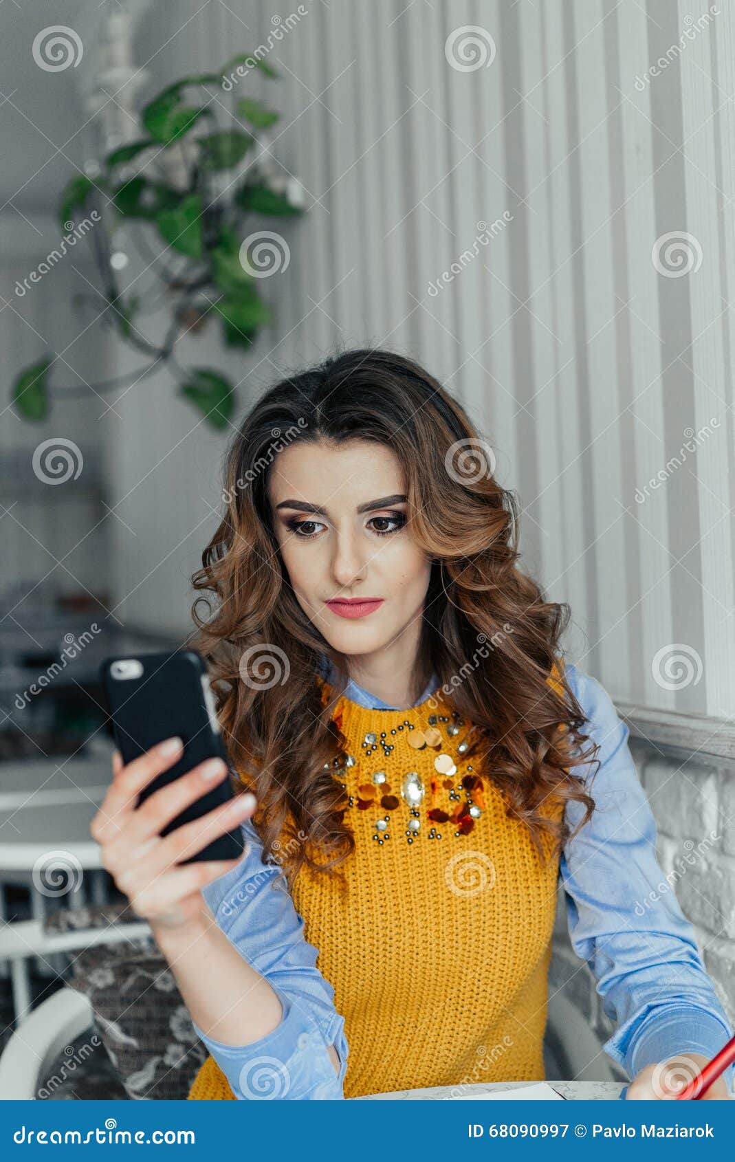 Lady using phone in a cafe stock image. Image of money - 68090997