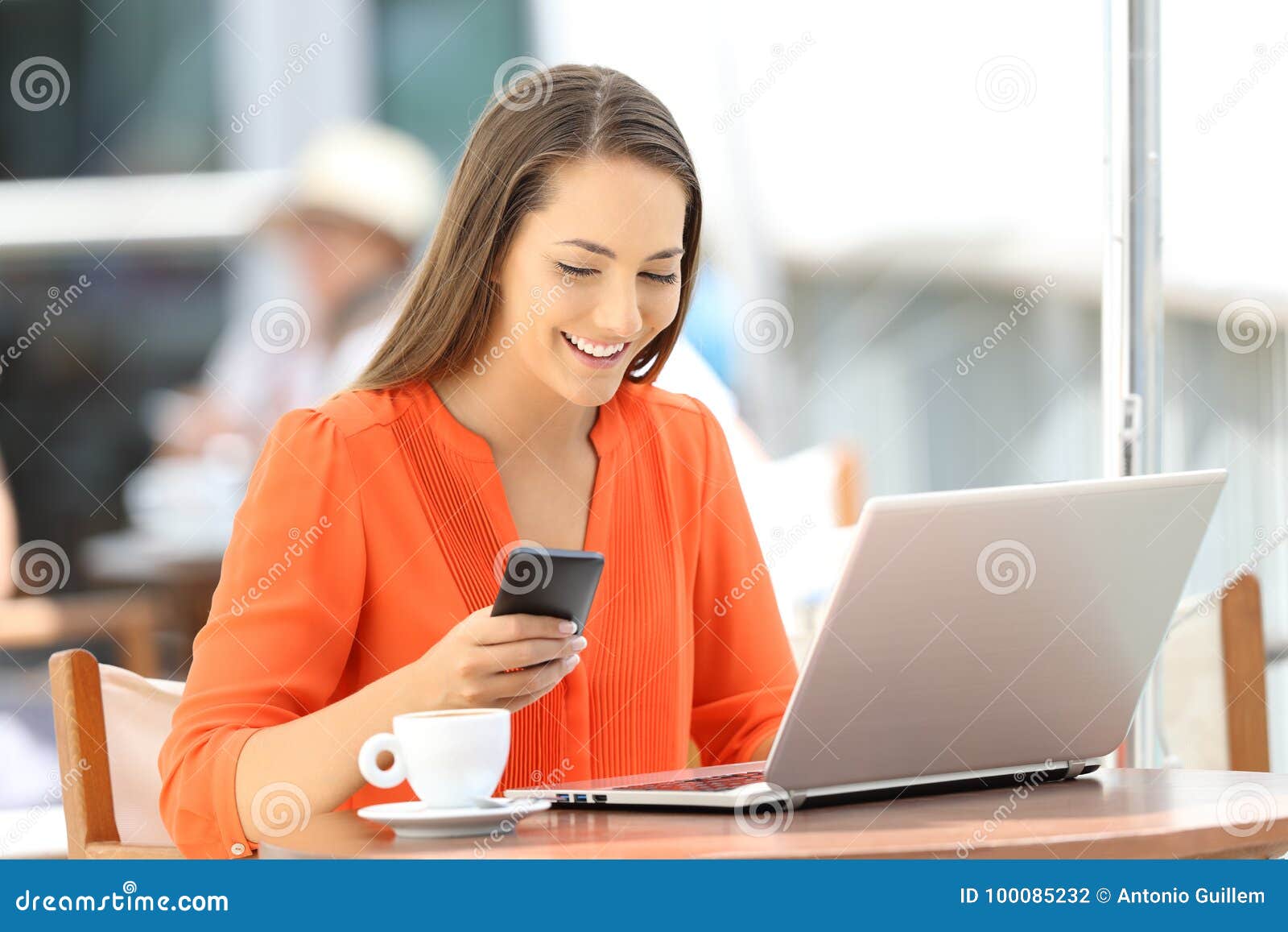 Lady Using a Phone and Laptop in a Bar Stock Photo - Image of browsing ...