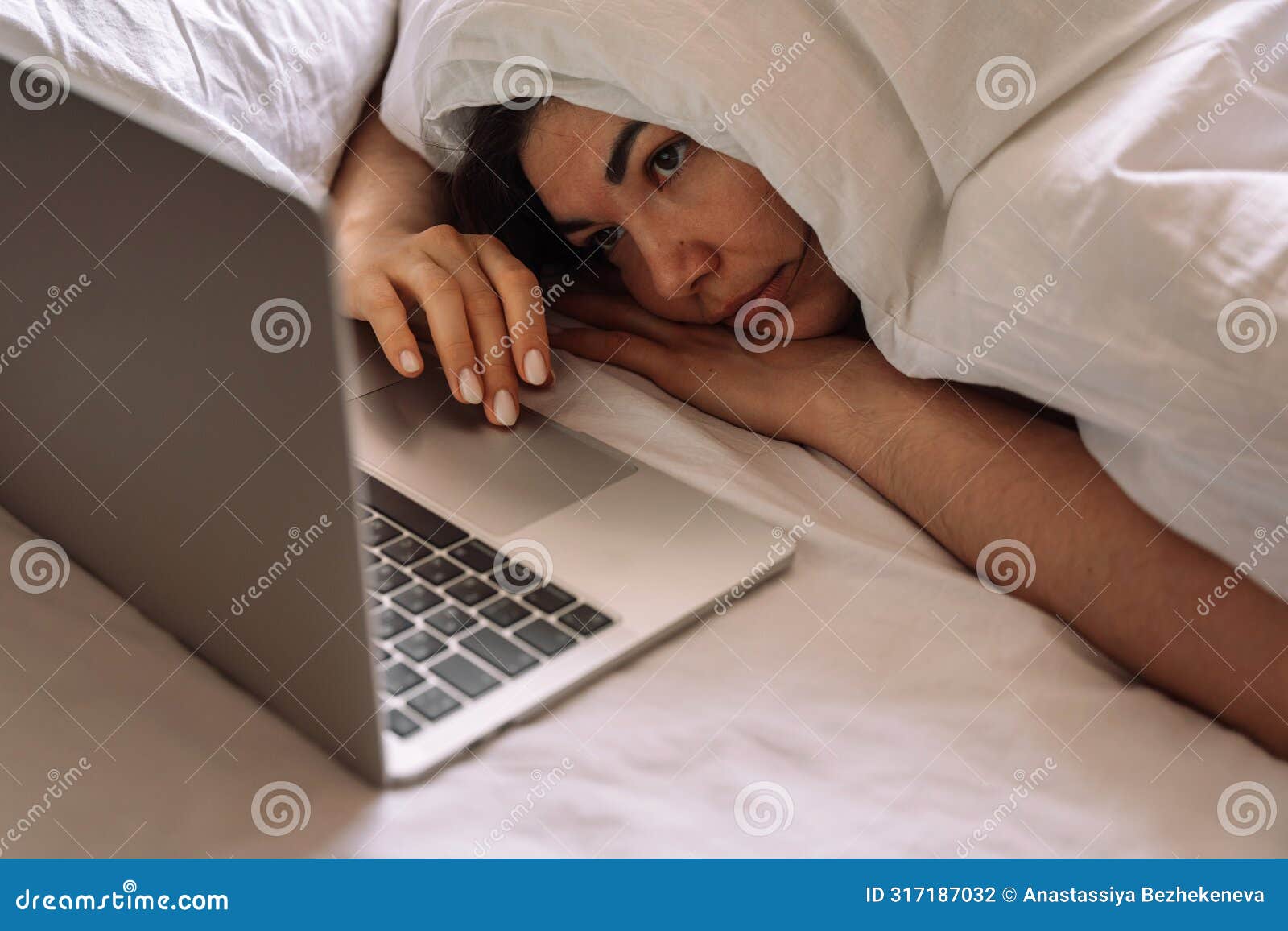 Lady Working Remotely while Lying in Bed Talking on a Video Call Stock ...