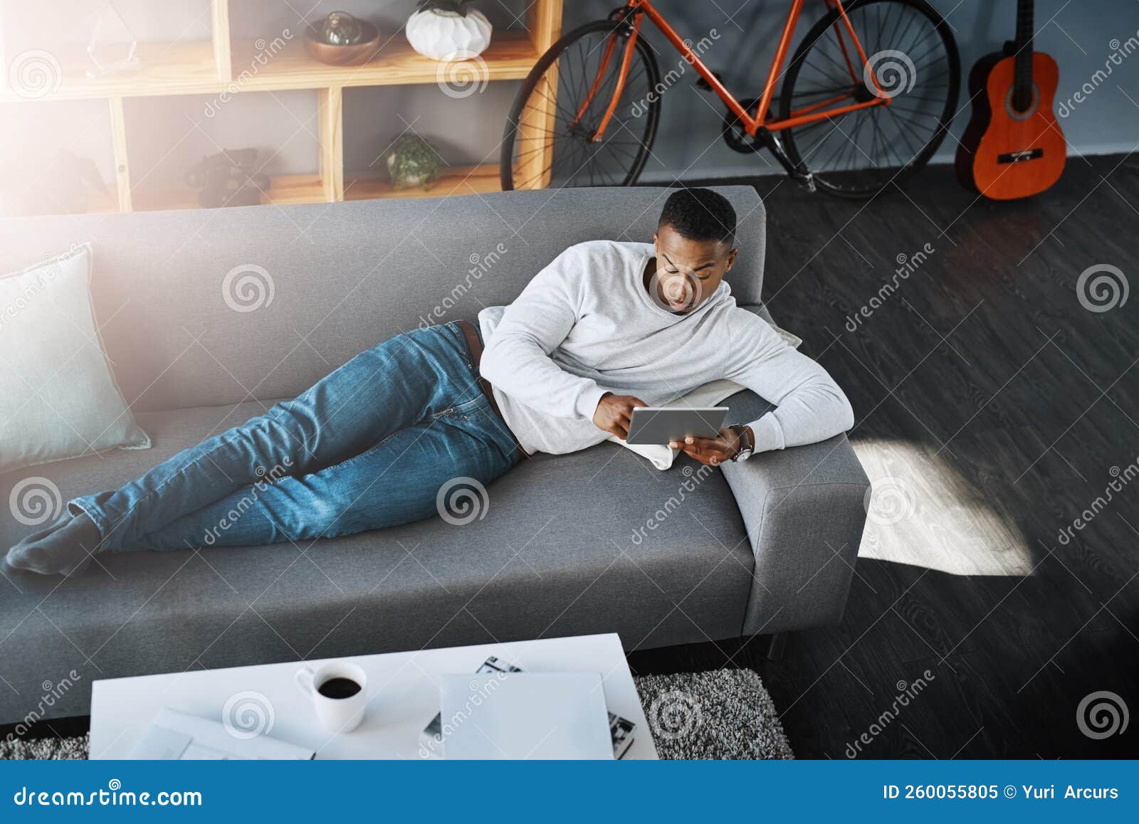 Laid Back and Taking it Easy. High Angle Shot of a Young Man Lying Down ...