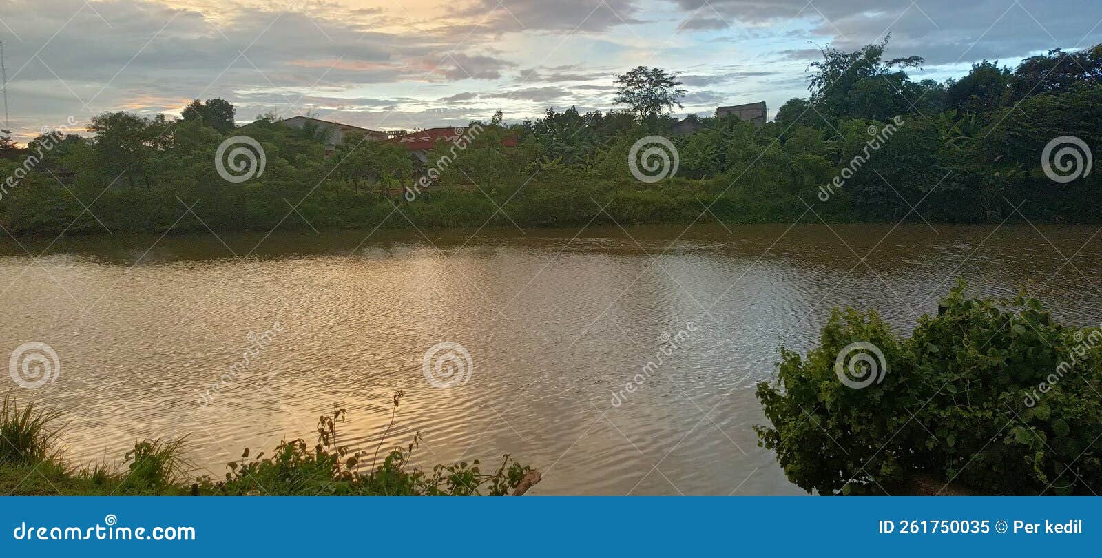 Lake in the afternoon stock image. Image of evening - 261750035