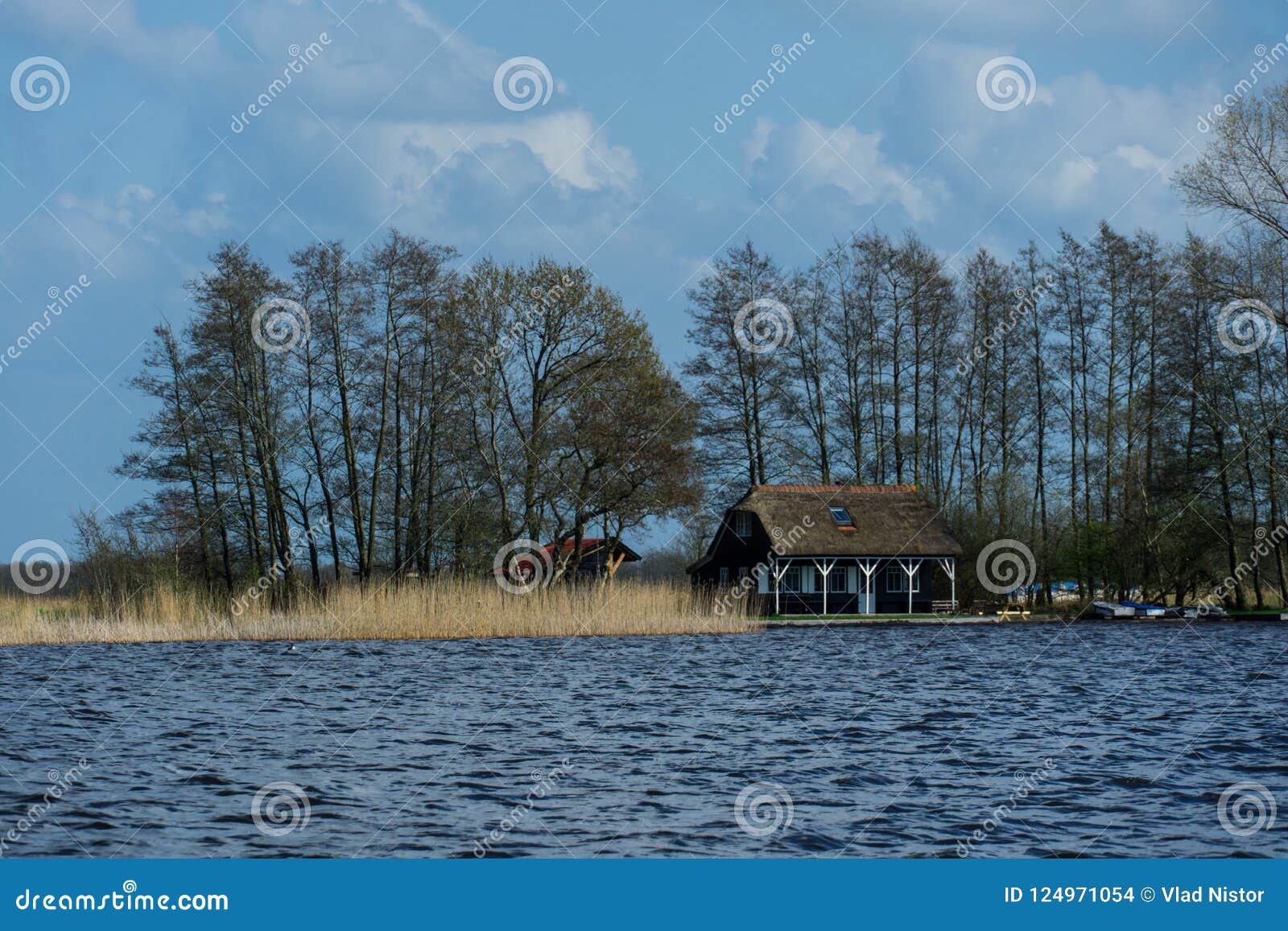 Lake House on a Blue Lagoon Stock Photo - Image of beautiful, blue ...
