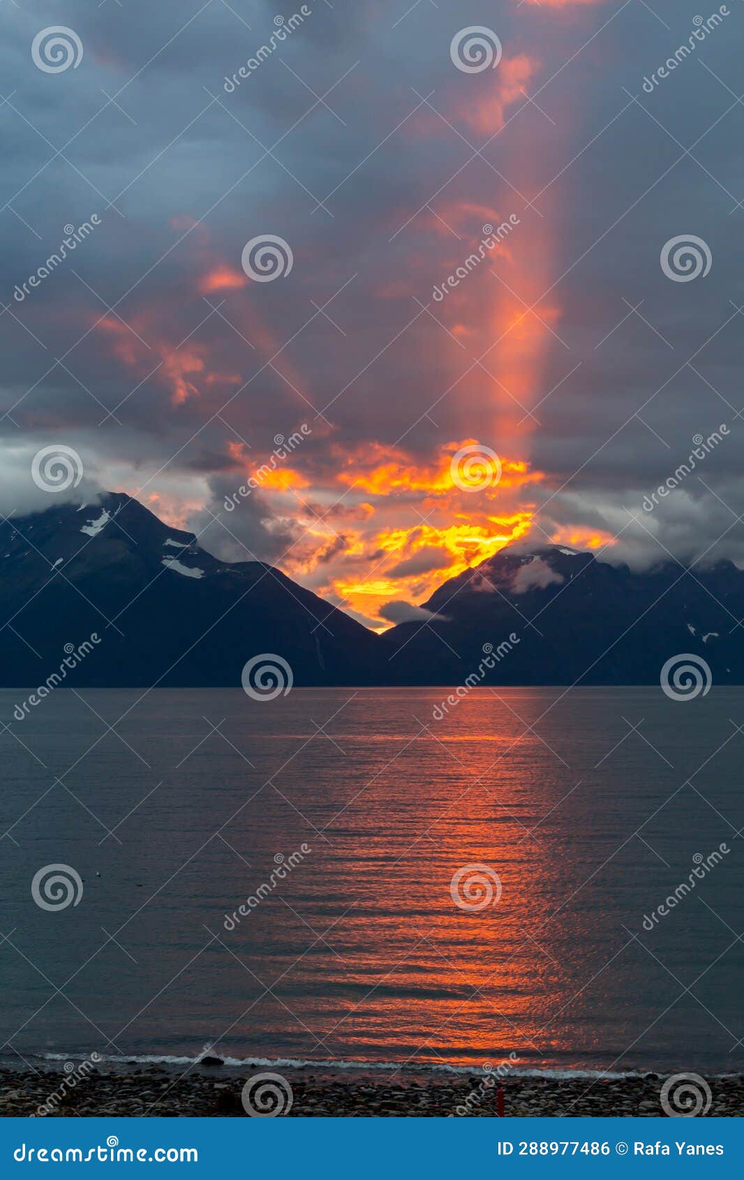 Lake with Illumination of the Sun in the Clouds Rising between ...