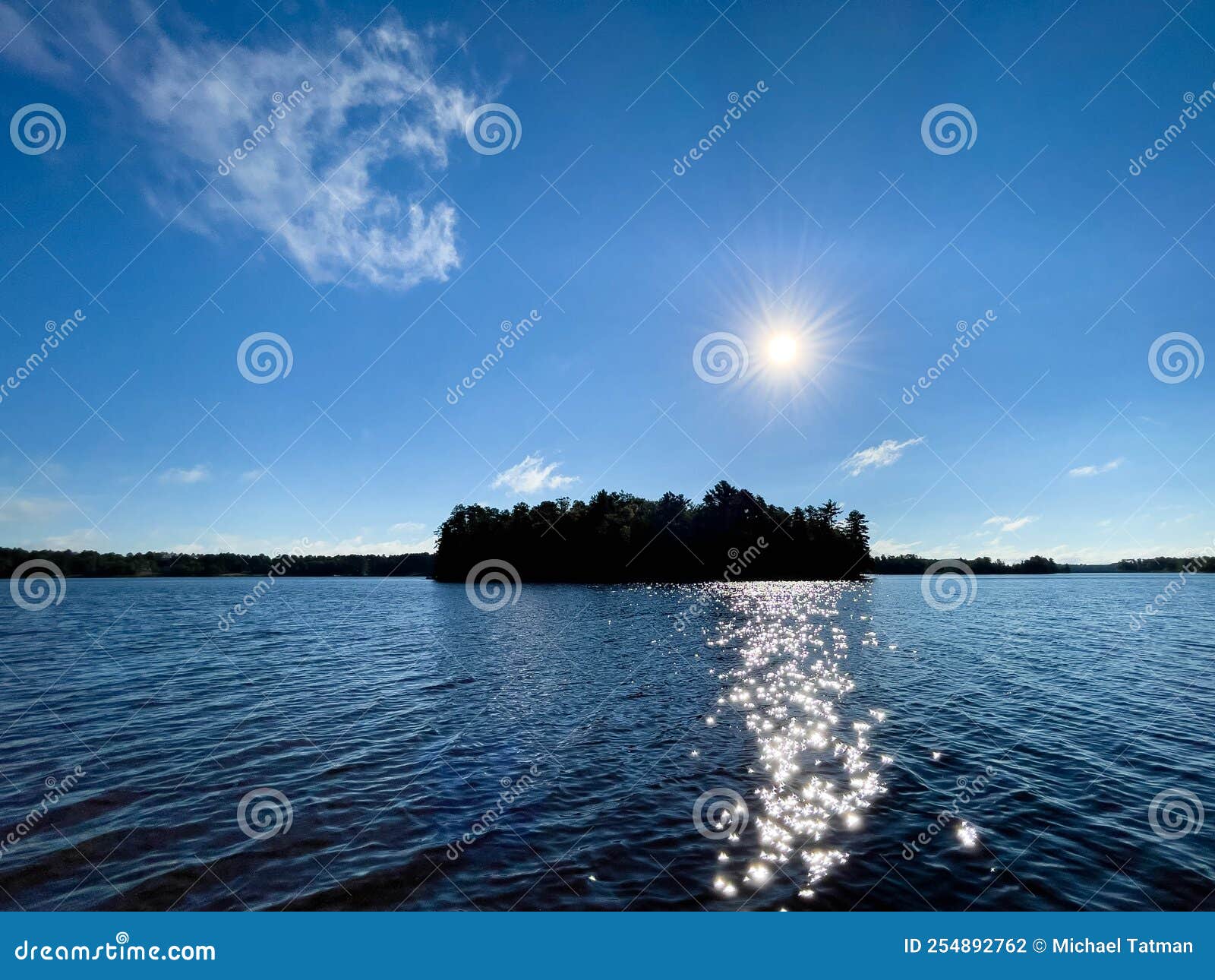 Lake with an Island and the Sun Shinning on the Water Stock Photo ...