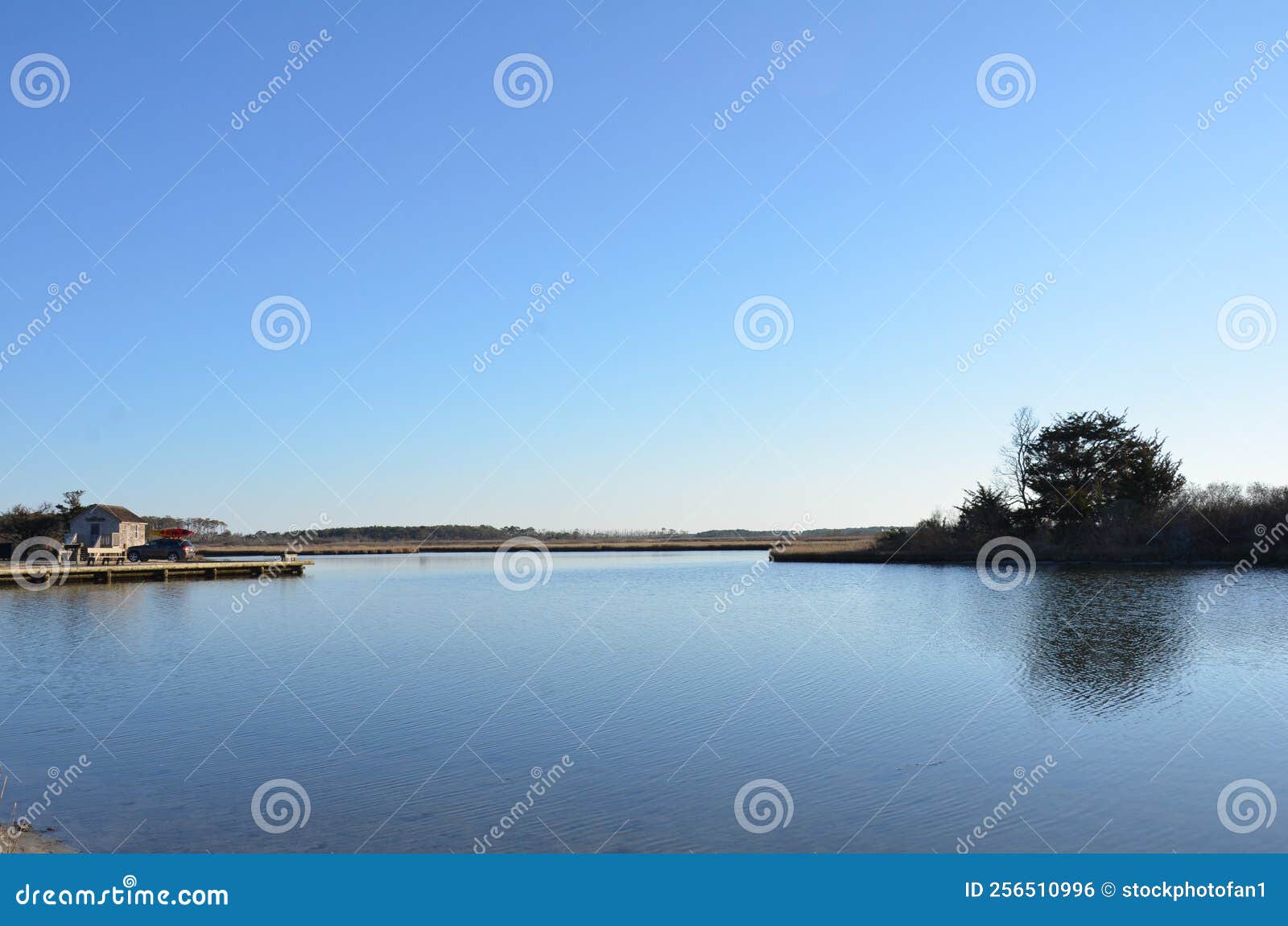 A Lake or River with Brown Grasses and Shore Stock Photo - Image of ...