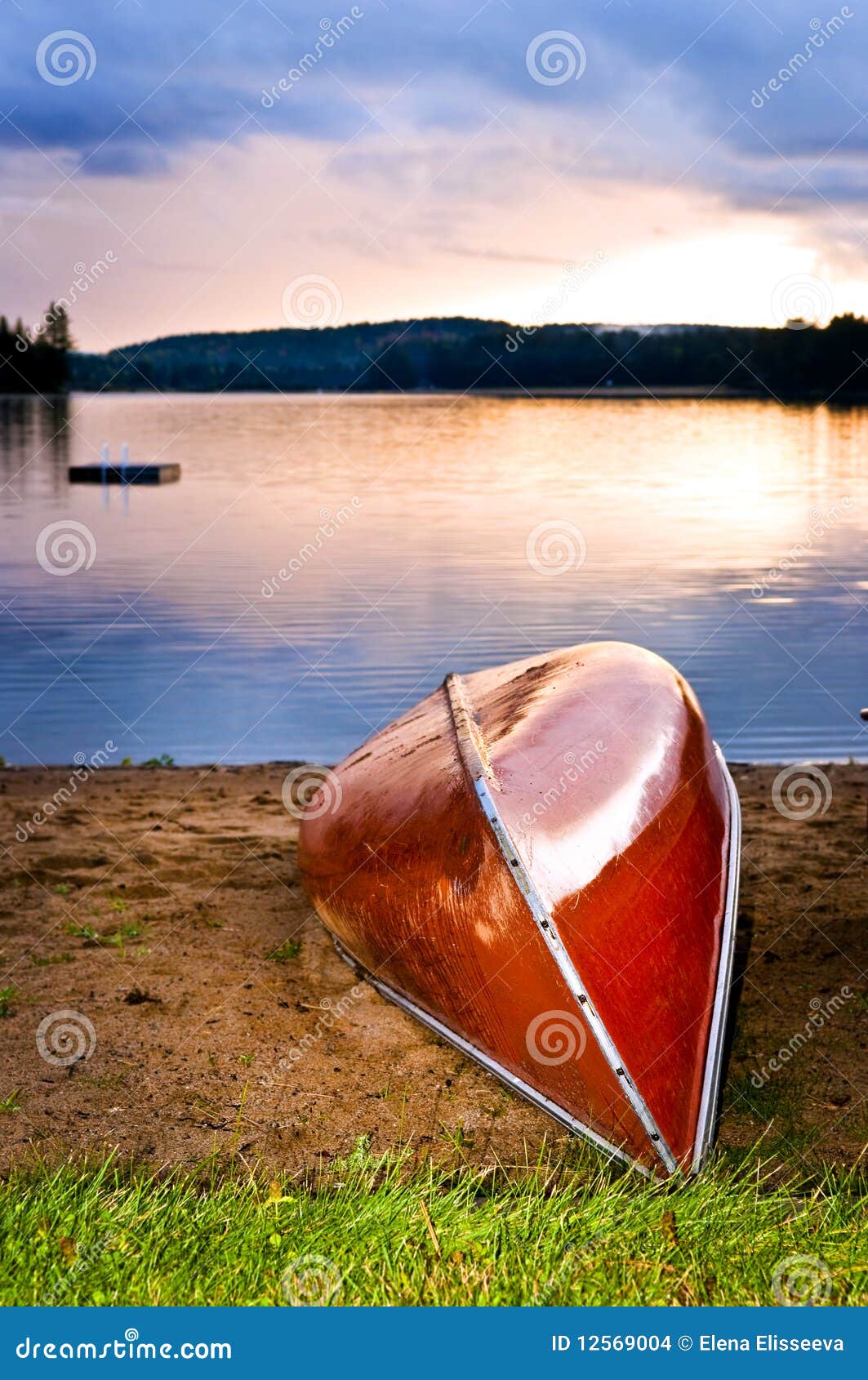Lake Sunset with Canoe on Beach Stock Photo - Image of peaceful, beach ...