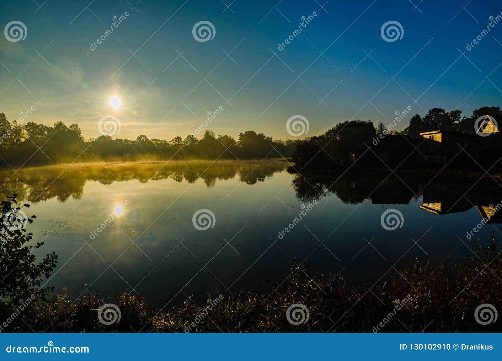 The Lake is Surrounded by Autumn Trees Reflected in the Mirror Surface ...