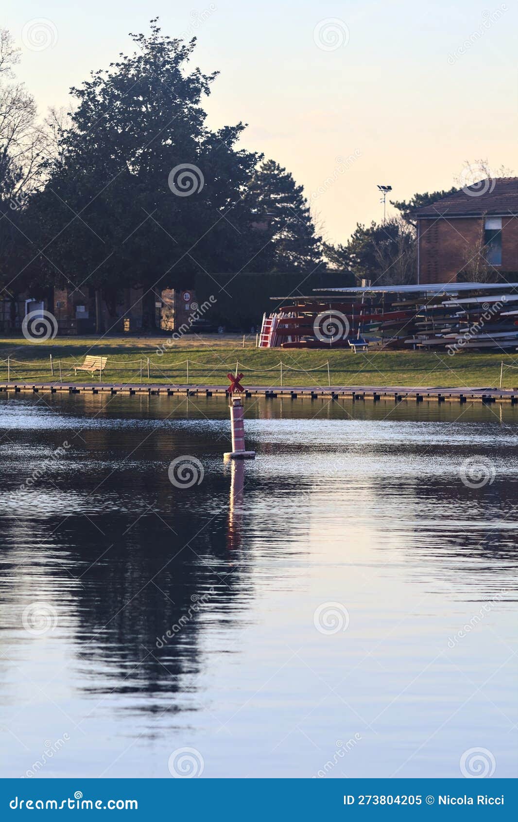 Lakeshore in a Residential Area at Sunset with Reflection Casted in the ...