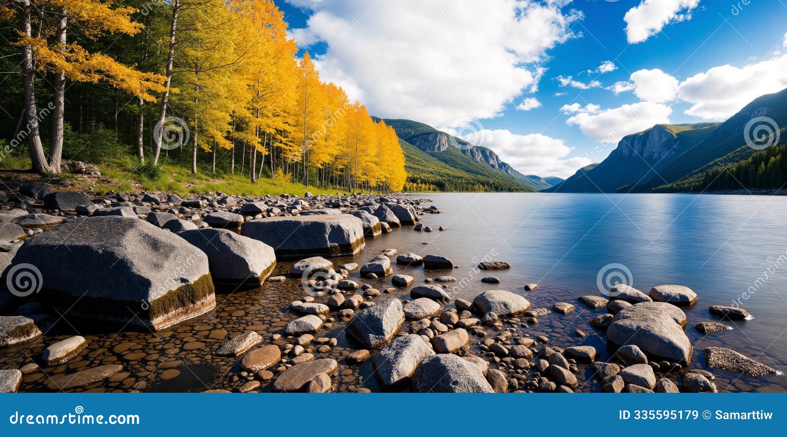 The Lakeside is Full of Rocks with Mountains and Clouds As a Background ...