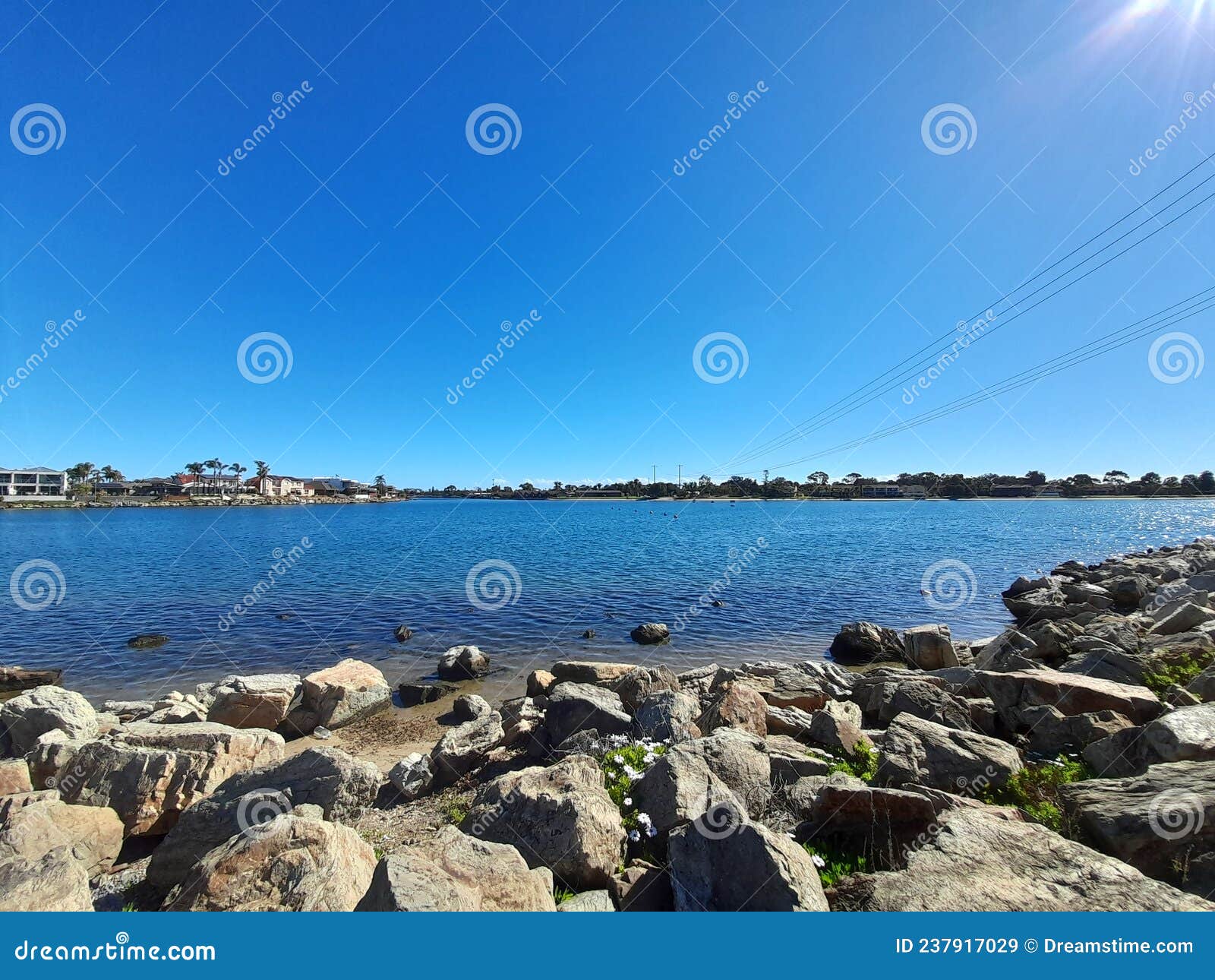 Lakeside and rocks horizon stock image. Image of cove - 237917029
