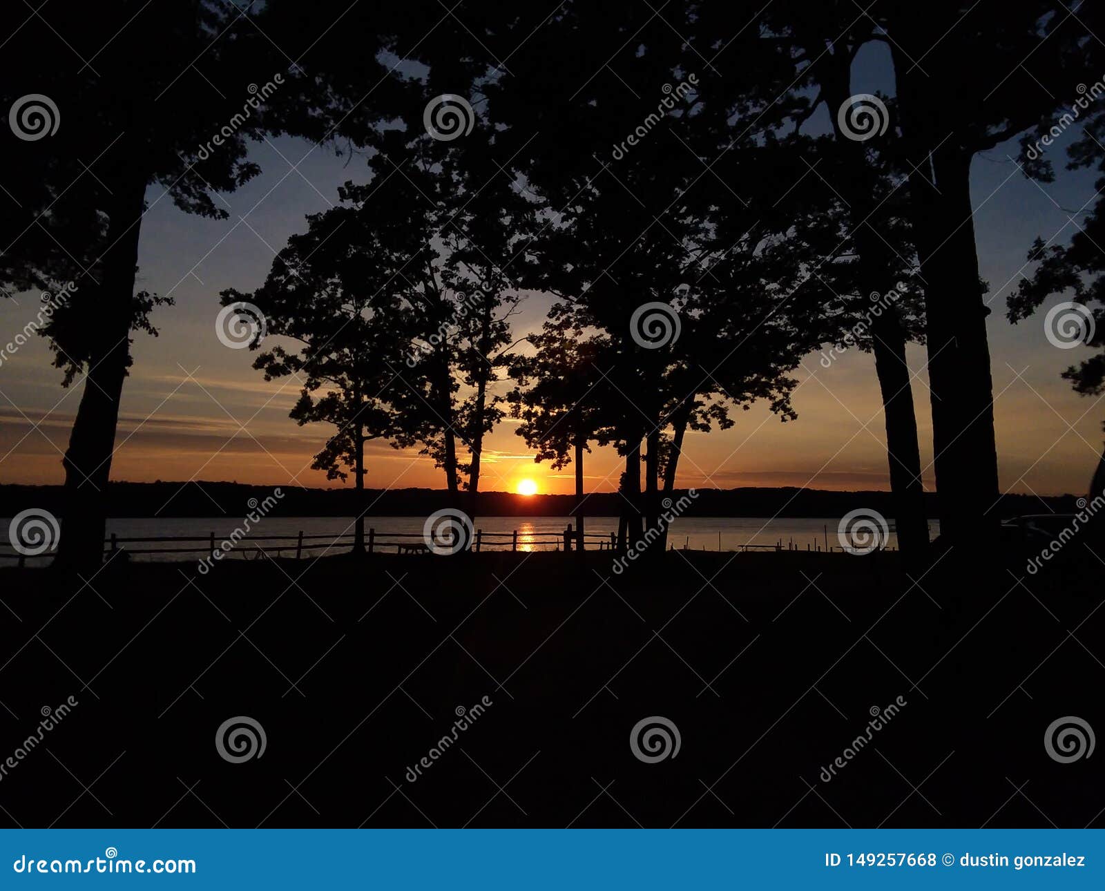 Lakeside sunset stock photo. Image of lakeside, bench - 149257668