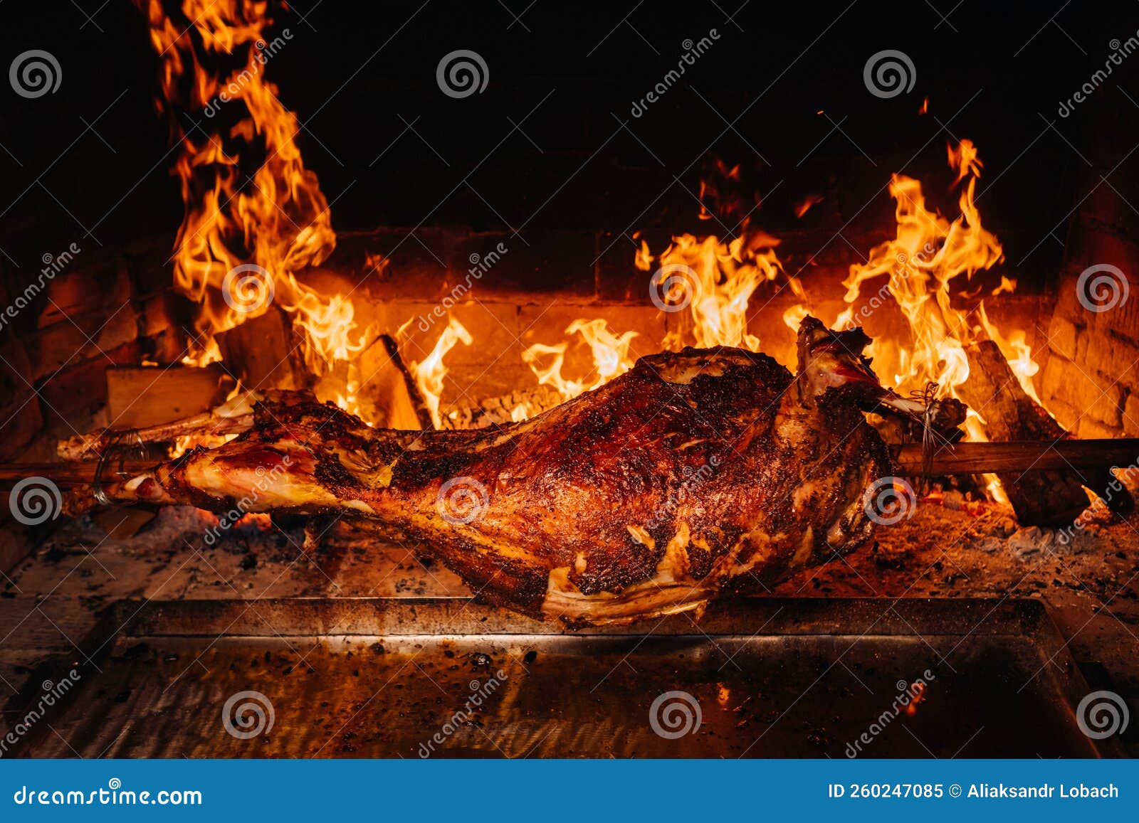 The Lamb is Cooked Entirely on a Spit on the Fire. Cooking Stock Image ...