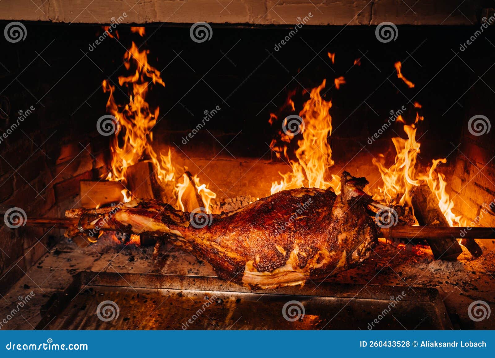 The Lamb is Cooked Entirely on a Spit on the Fire. Cooking Stock Photo ...