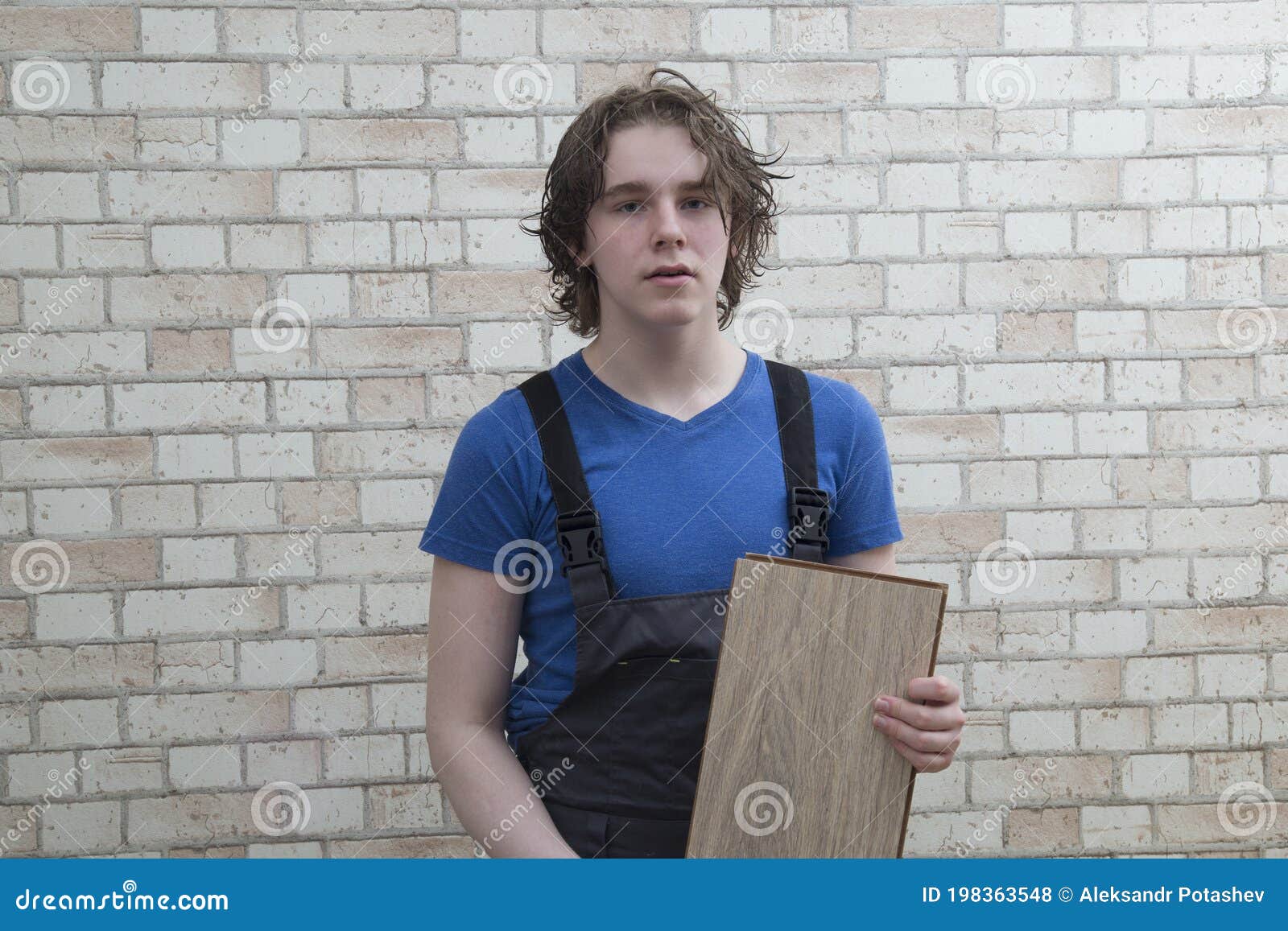 Laminate for Installation on the Floor. Worker with a Sheet of Laminate ...