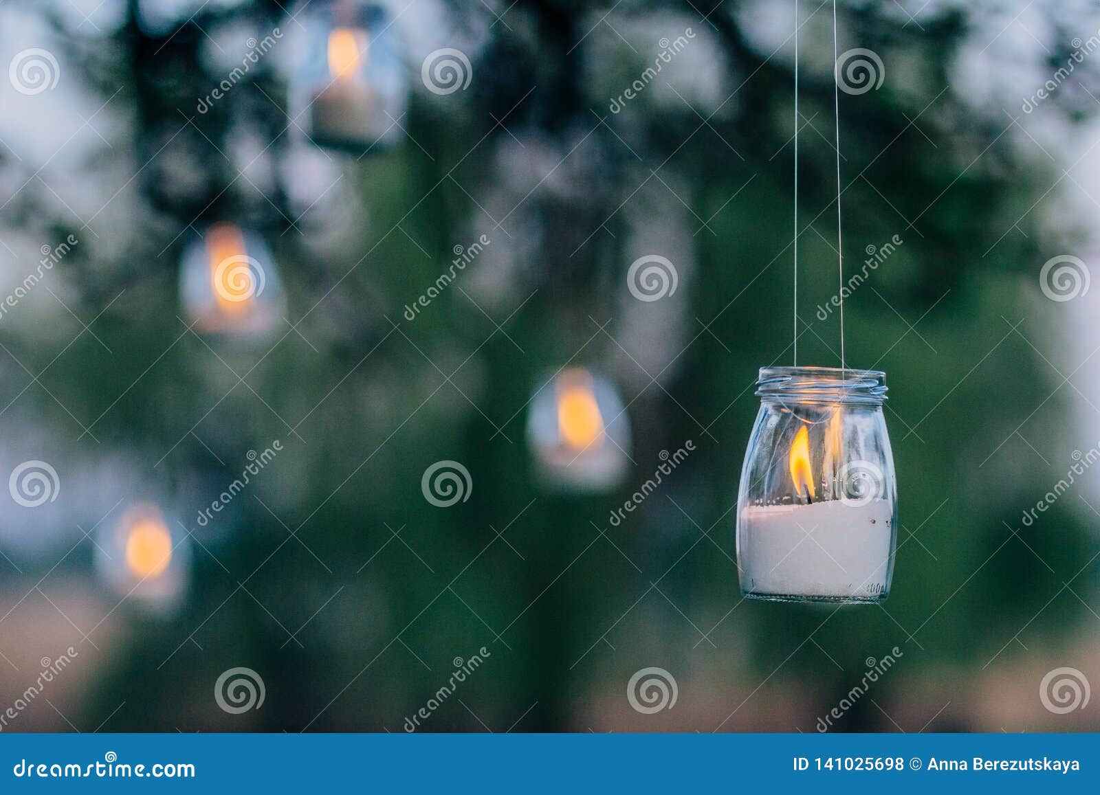 The Lamp Made of a Jar with a Candle is Hanging on a Tree at Night ...