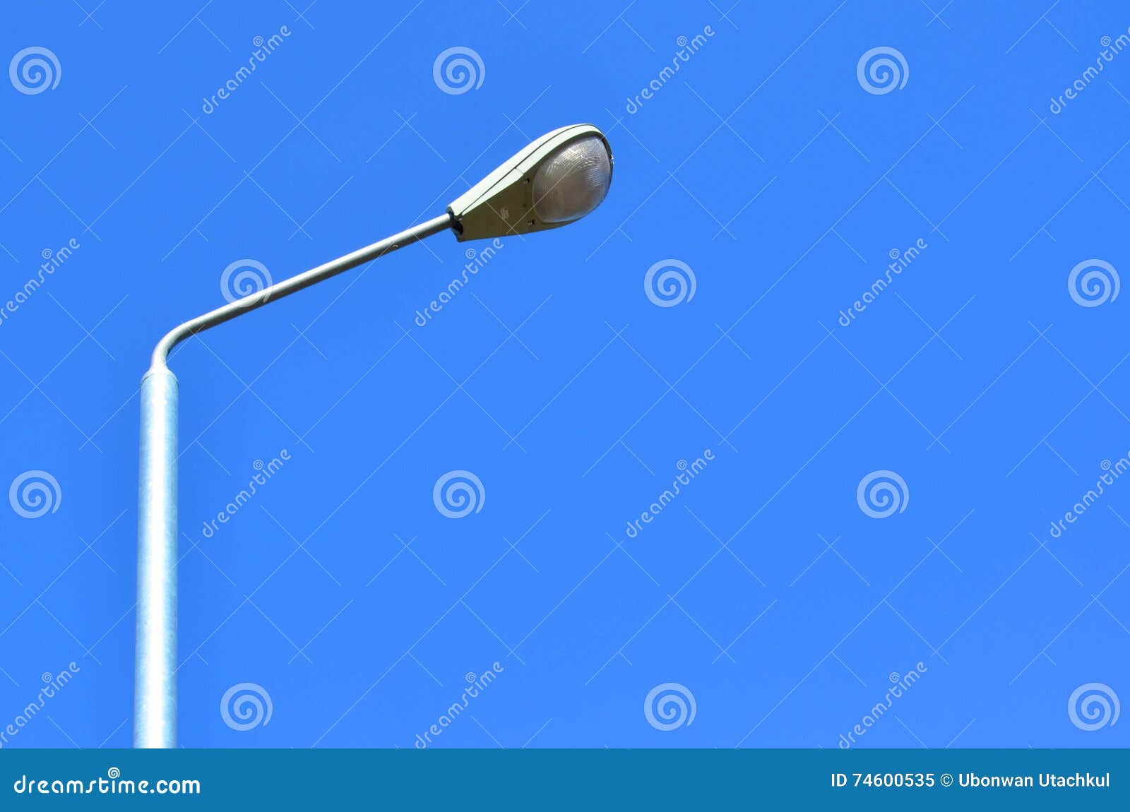 Lamp post against blue sky stock image. Image of power - 74600535