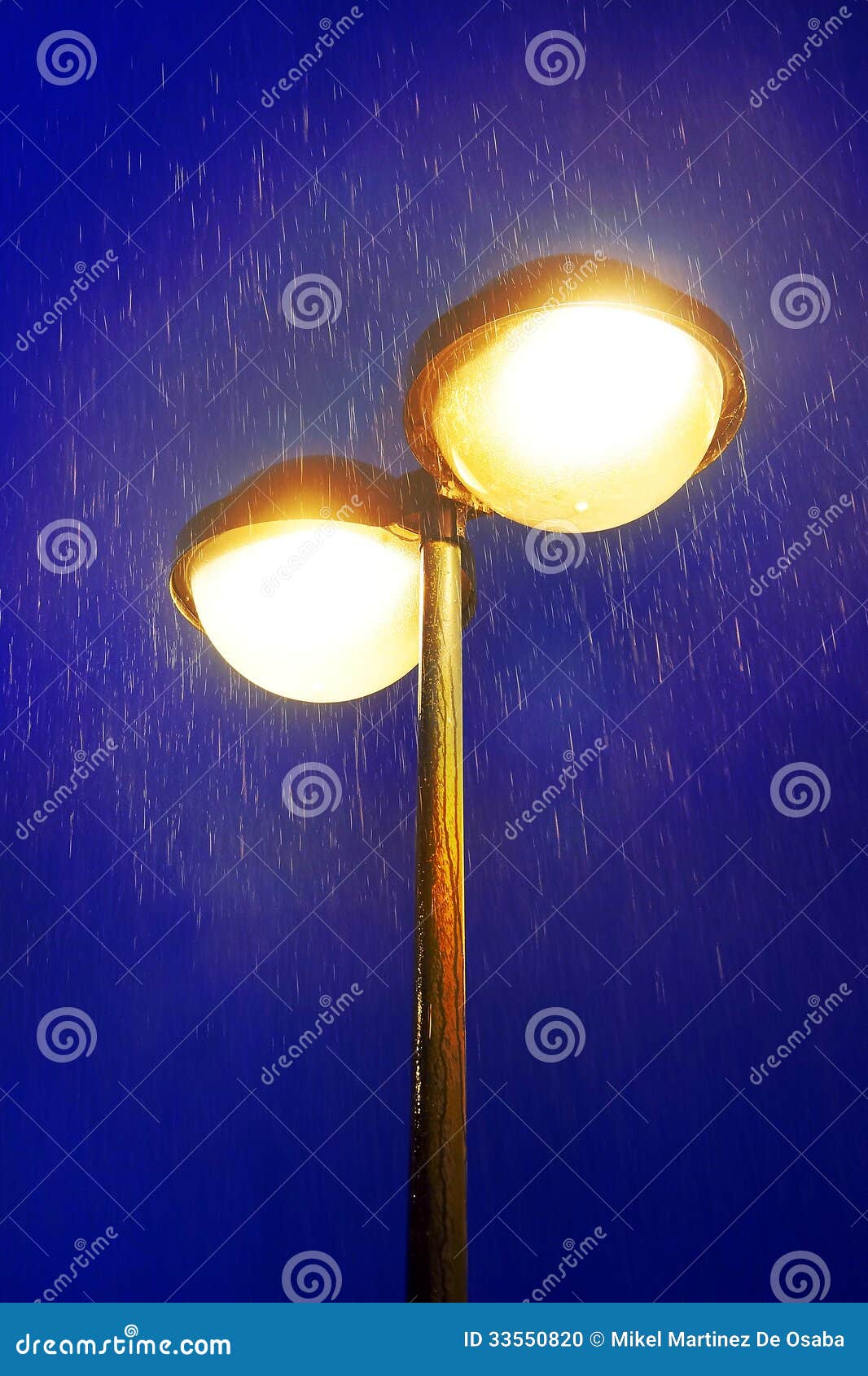 Lampost at night with rain stock photo. Image of city - 33550820