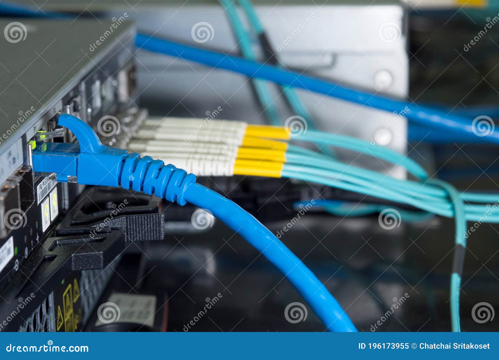 Lan and Fiber Optic Cables are Plugged into the Back Panal of the ...