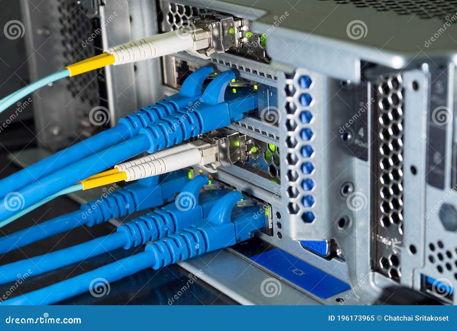 Lan and Fiber Optic Cables are Plugged into the Back Panal of the ...