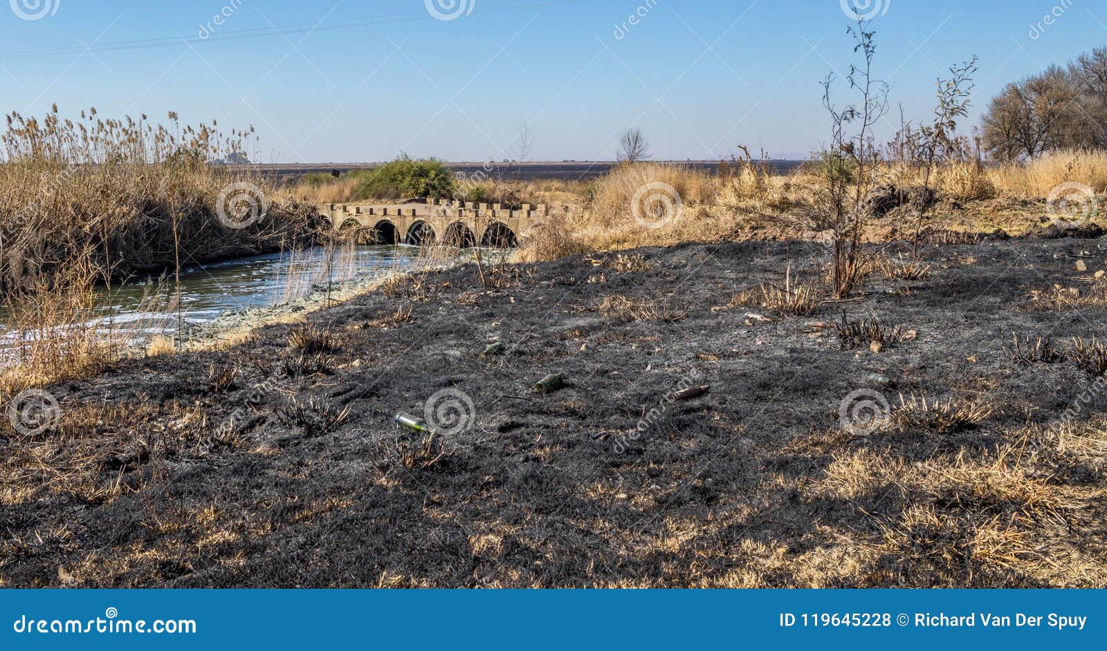 Landscape with Burnt Field and an Old Bridge Stock Photo - Image of ...