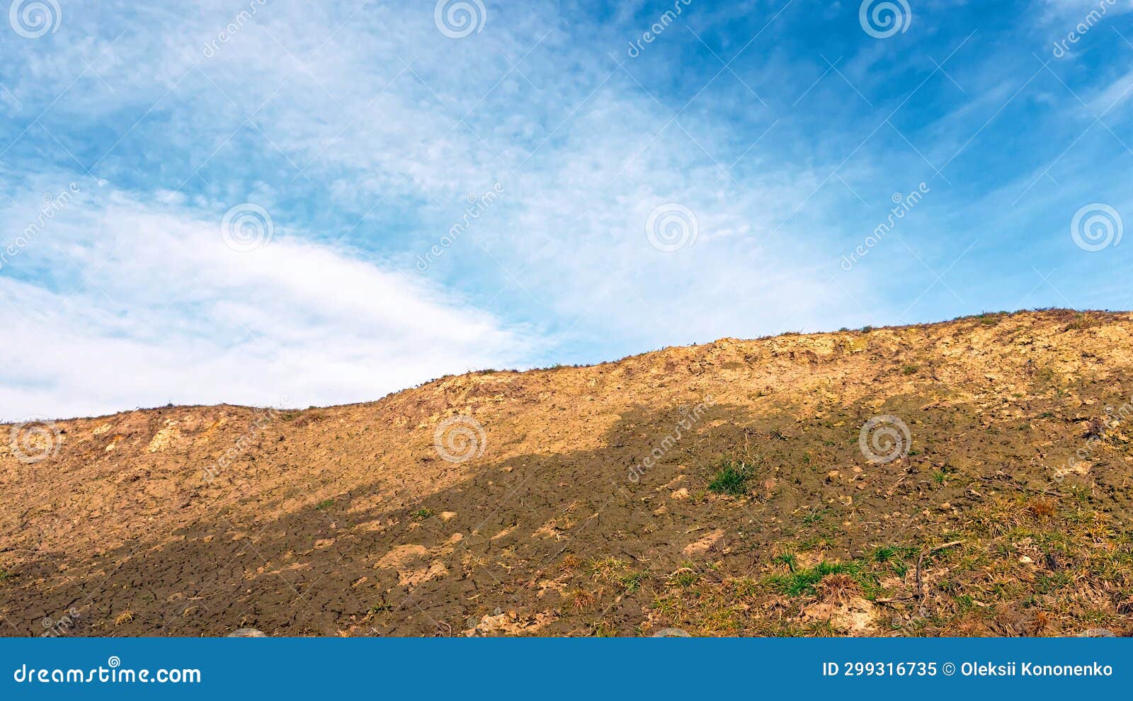 A Landscape Photo Captures a Grassy Hillside Under a Clear Blue Sky ...