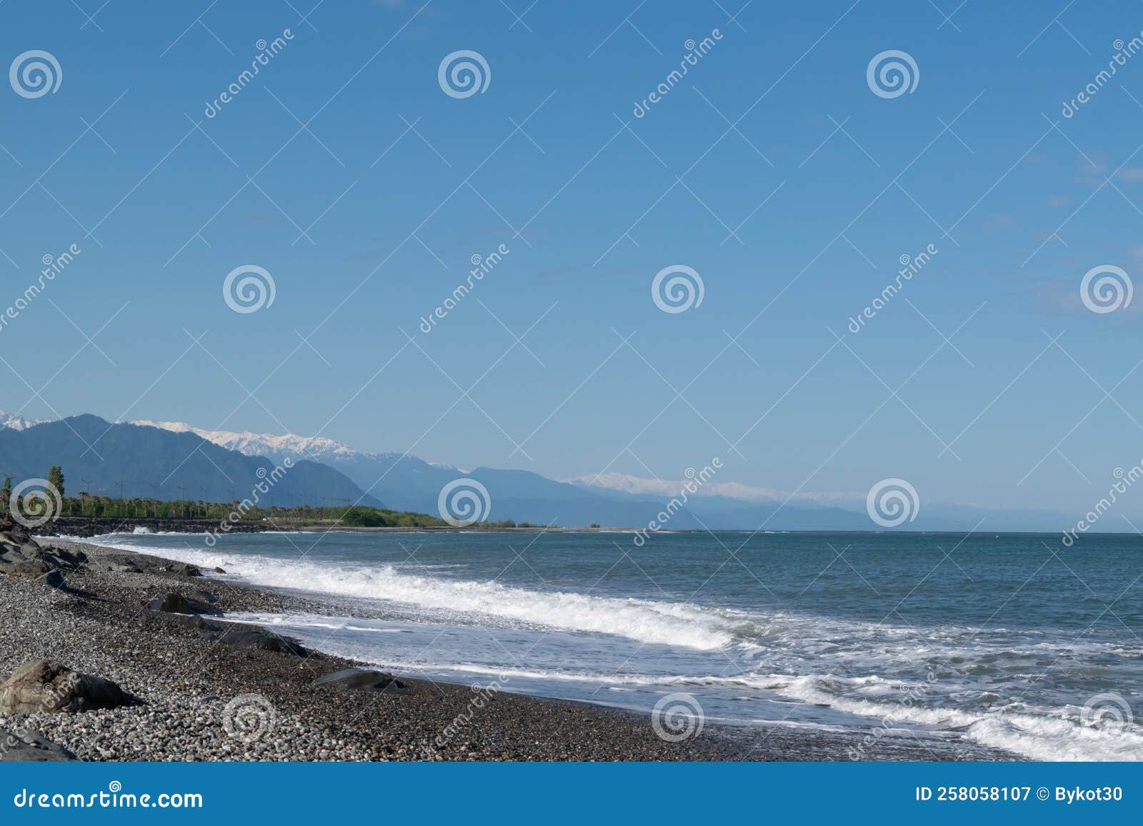 Seascape with Waves, Rocky Shore and Mountains in the Distance. Stock ...