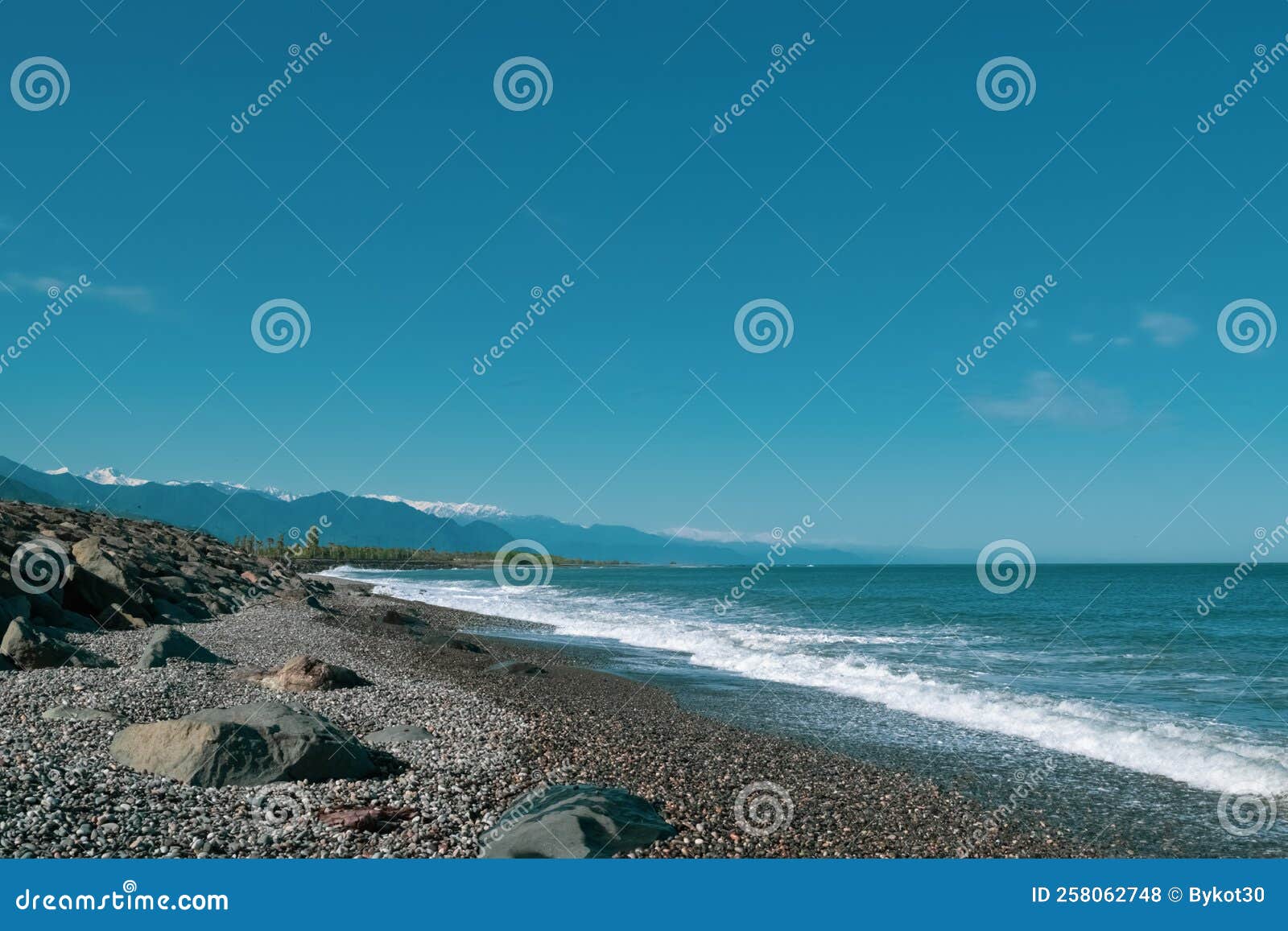 Beautiful Seascape. Waves, Rocky Shore, Mountains in the Distance Stock ...