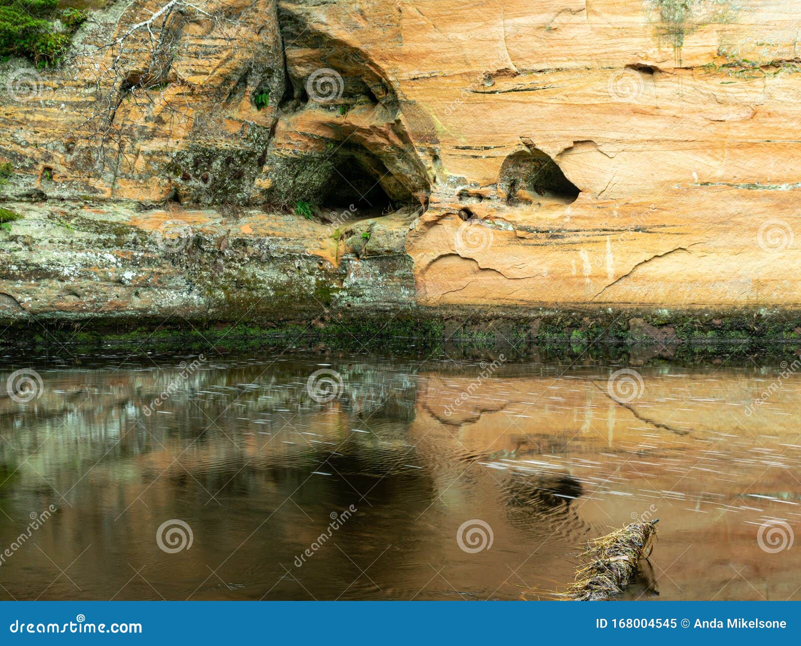 A Landscape with a Steep River and Caves on a Sandstone Cliff Stock ...