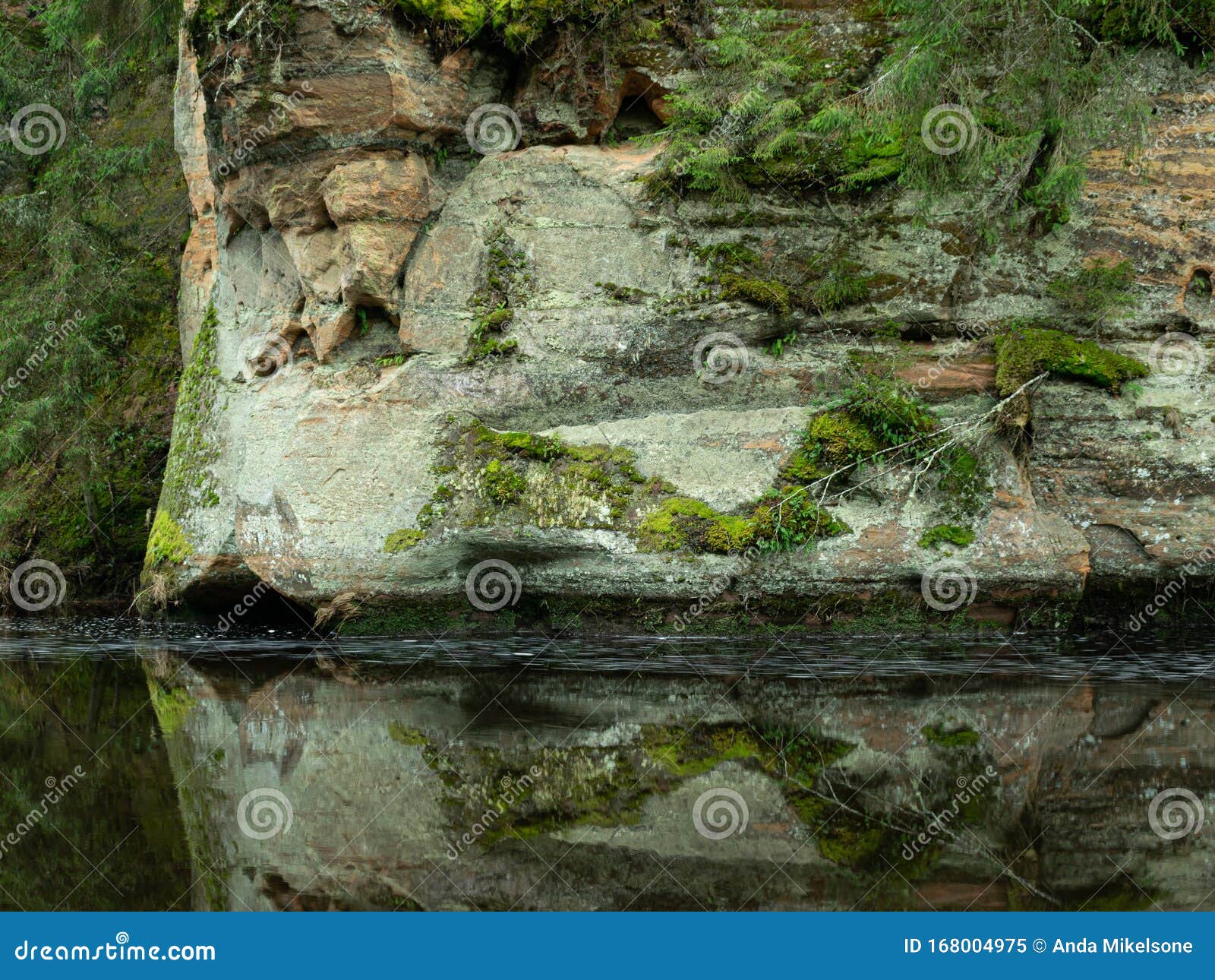 A Landscape with a Steep River and Caves on a Sandstone Cliff Stock ...