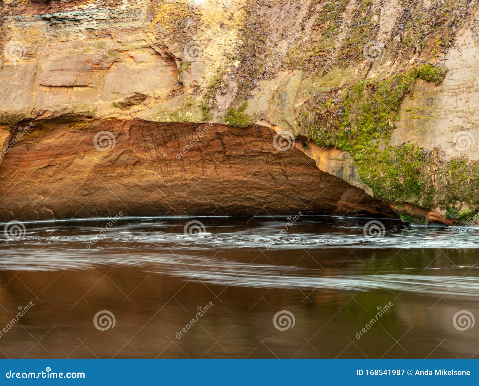 A Landscape with a Steep River and Caves on a Sandstone Cliff Stock ...