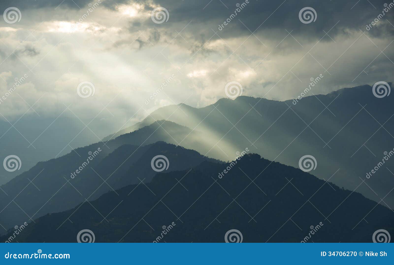 Landscape - Sun Rays through Cloud Over Hills Stock Photo - Image of ...