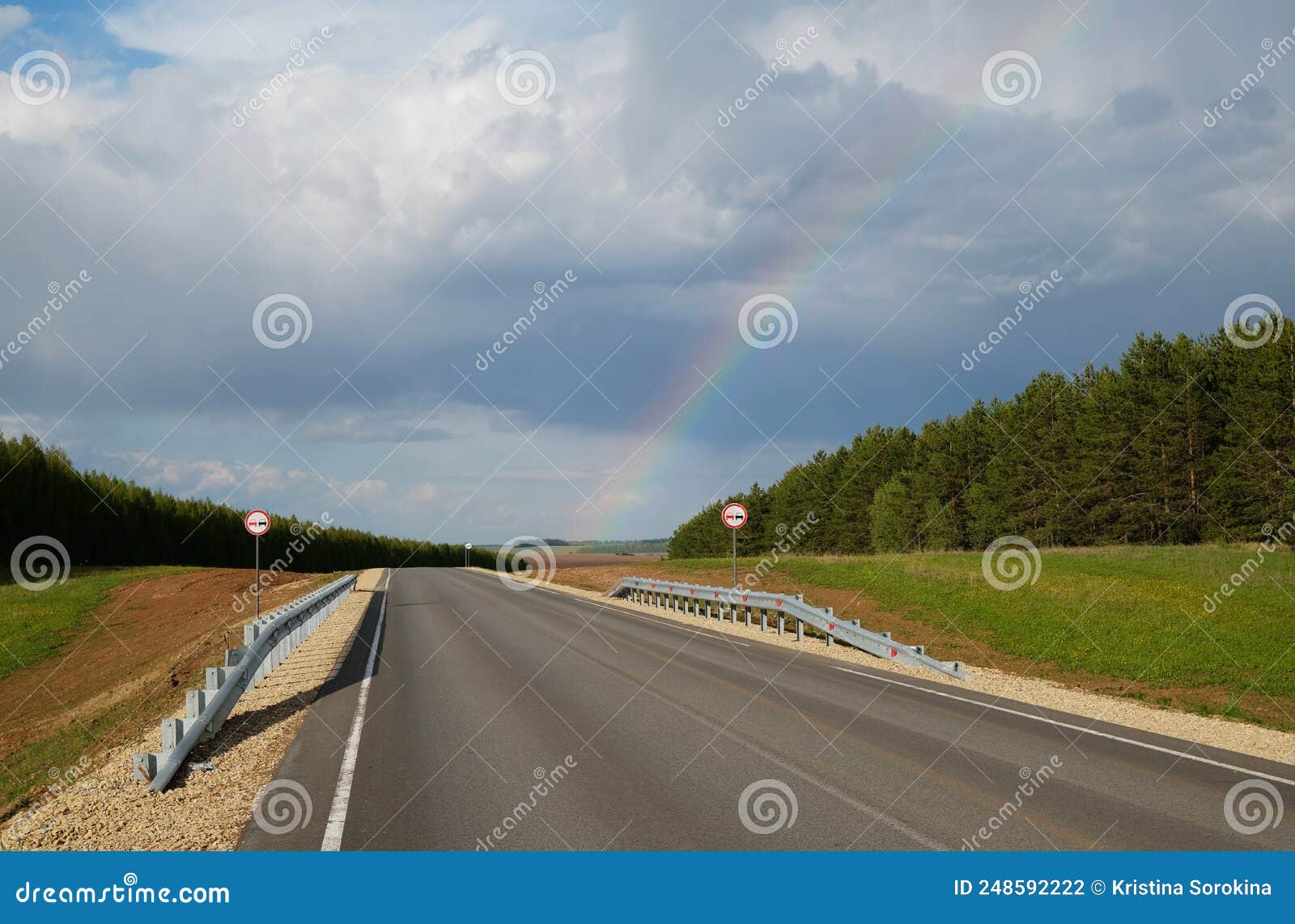 Landscape Track Road Along Green Fields. Rainbow in the after-rain Sky ...