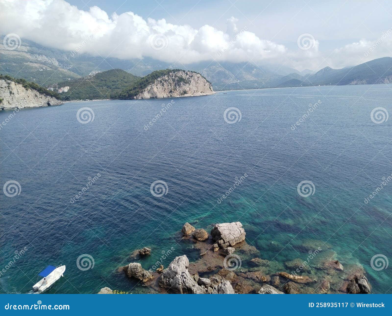 Landscape View of a Lake with Cliffs and Mountains in the Background ...