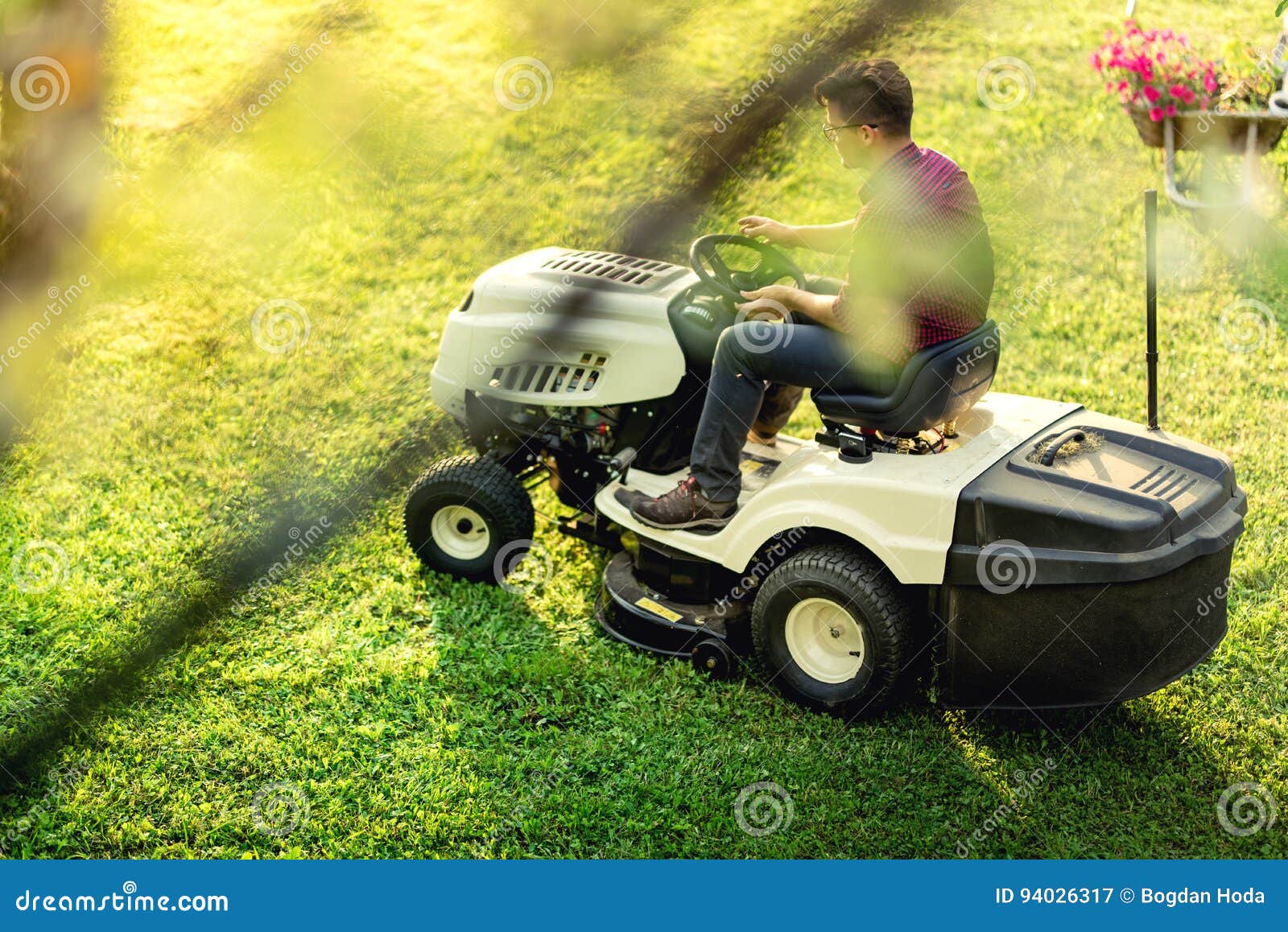Landscaping with Man Trimming Grass while Using a Lawnmow Stock Image ...