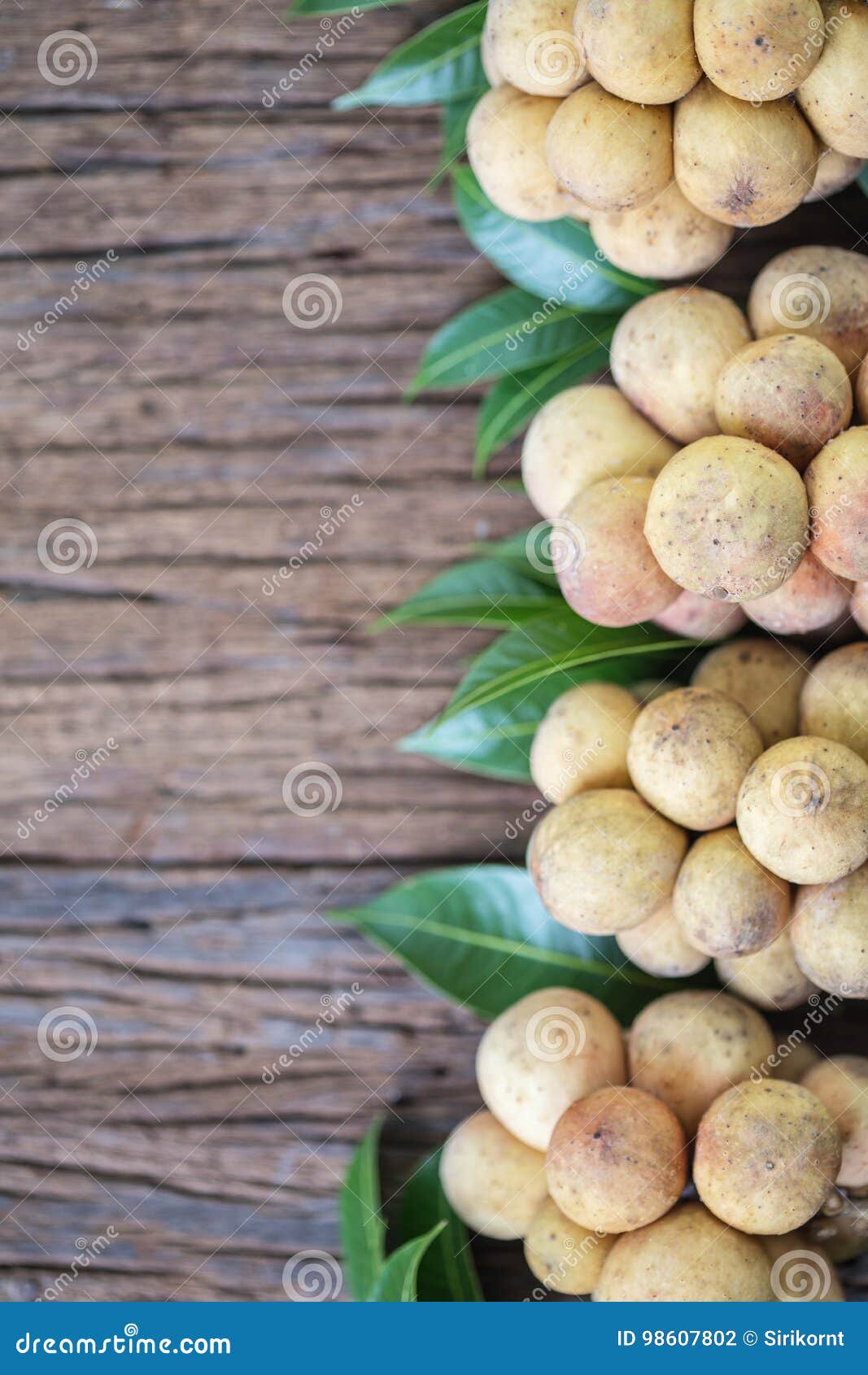 LangSat Thai Fruit with Green Leave on Wooden Background, Stock Photo ...