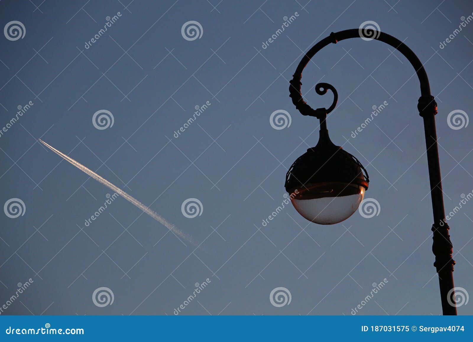 A Lantern and an Airplane Flying into the Distance Stock Image - Image ...