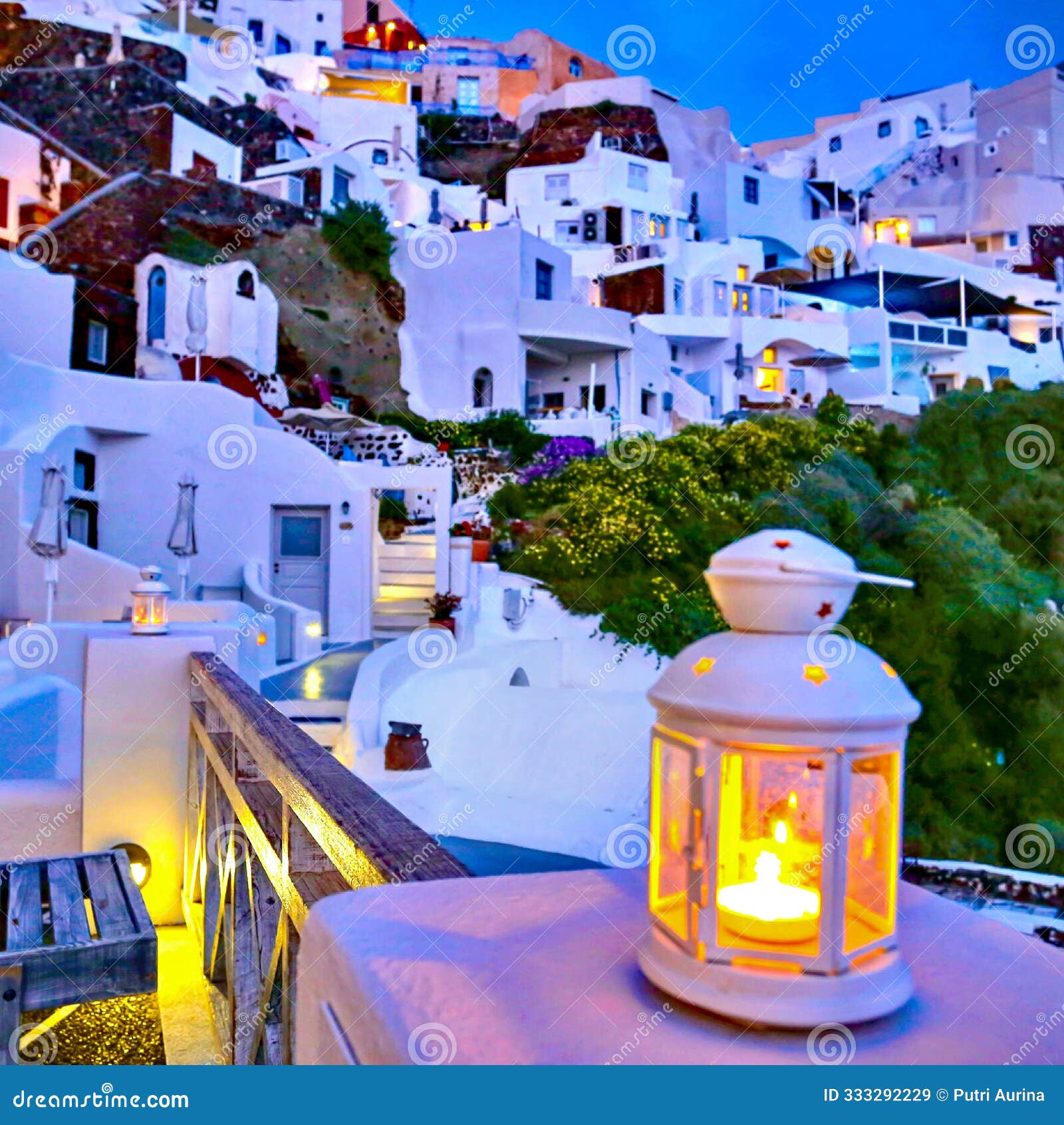 A Lantern is Lit in Front of a Whitewashed Greek Buildings in Santorini ...